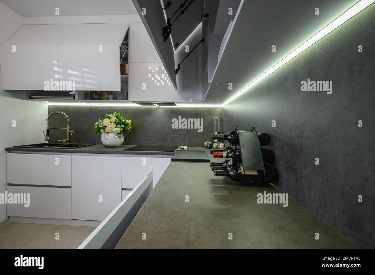 Dark grey counter counter top at white trendy kitchen Stock Photo - Alamy