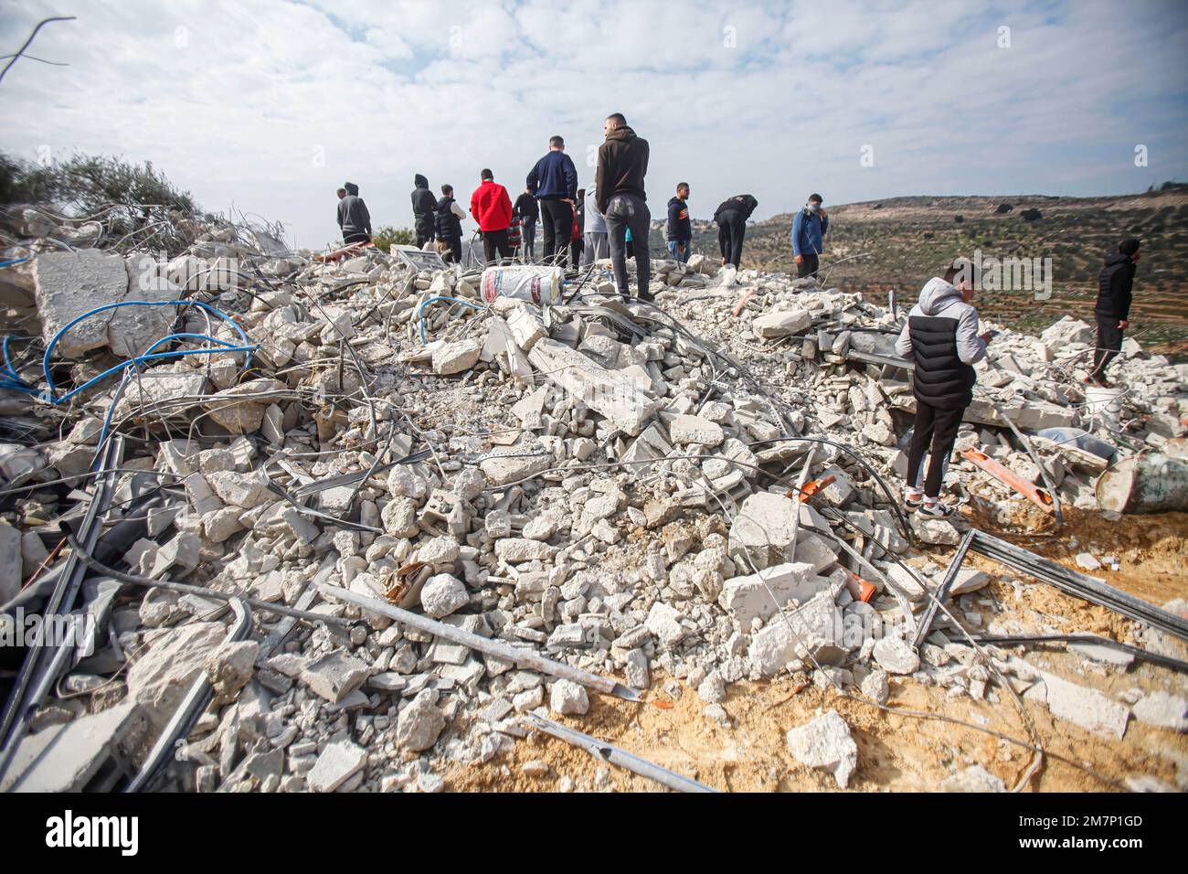 Salfit, Palestine. 10th Jan, 2023. Palestinians inspect the debris of a ...