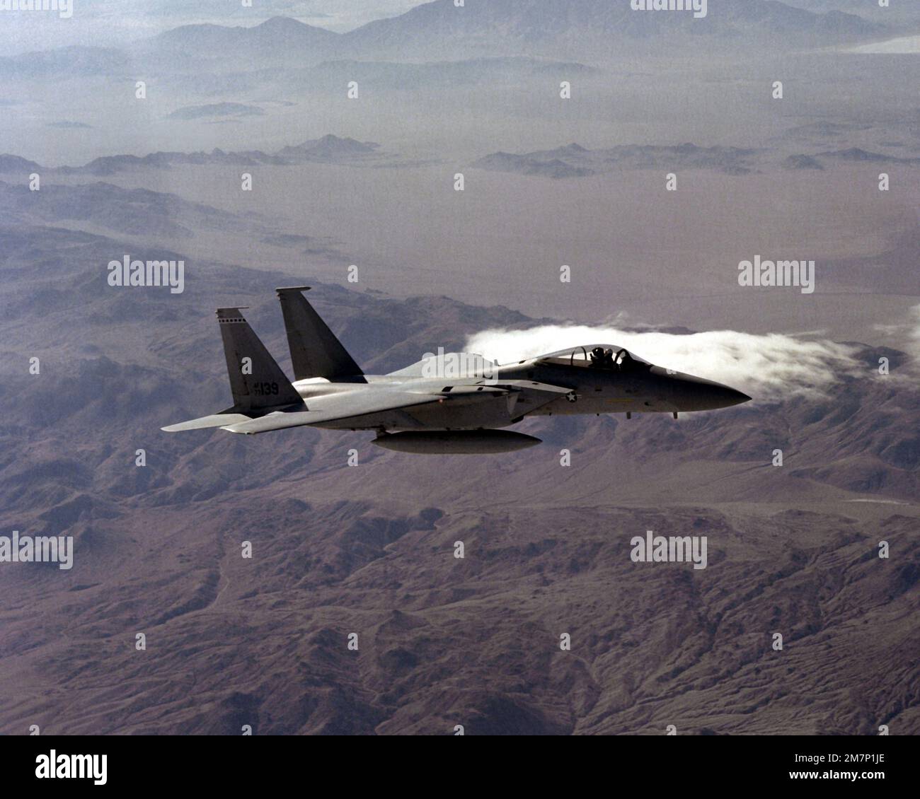 An air-to-air right side view of an F-15 Eagle aircraft. Country ...