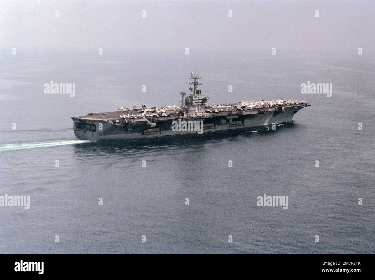 A starboard quarter view of the nuclear-powered aircraft carrier USS NIMITZ (CVN 68) underway ...