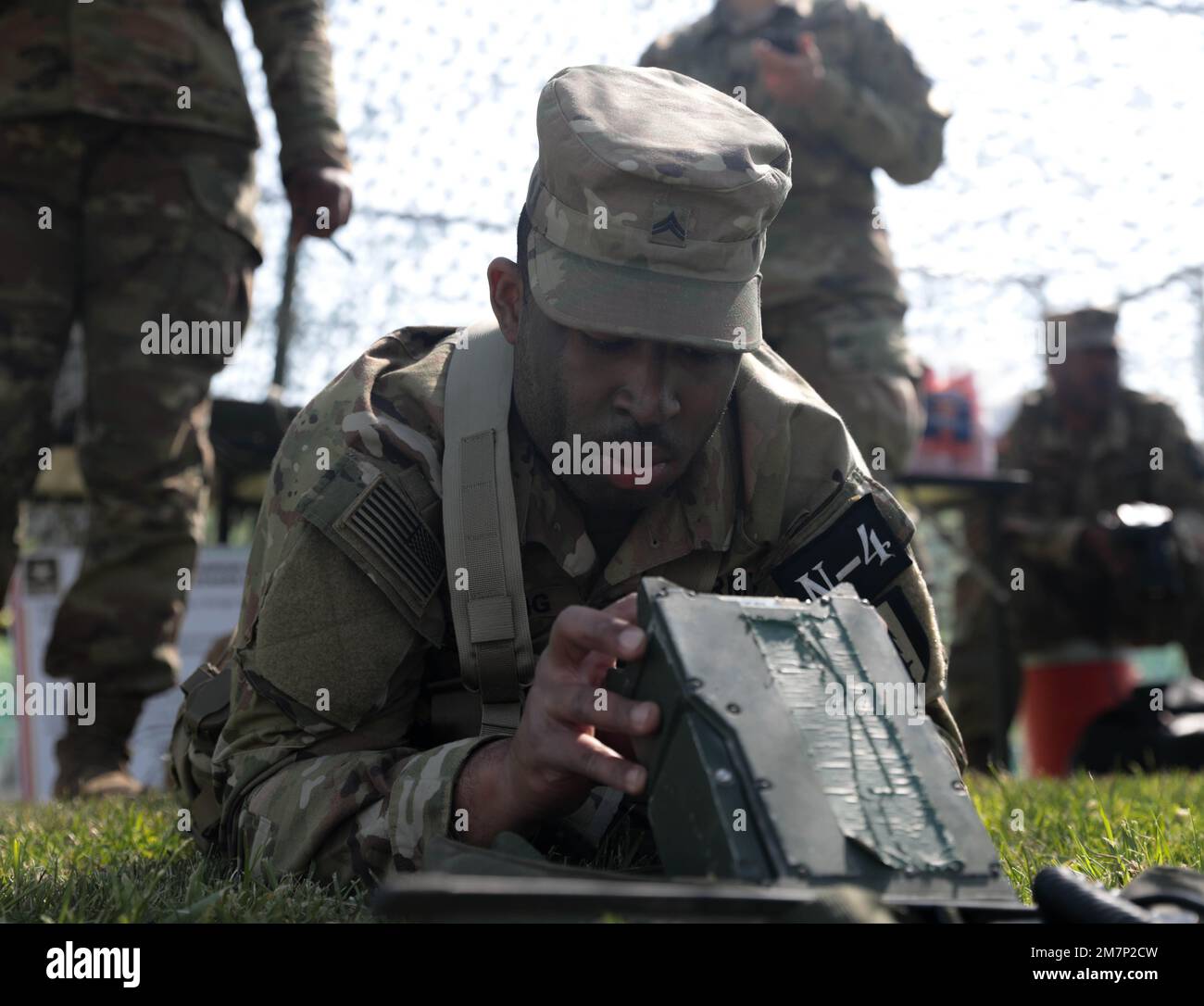 U.S. Army Cpl. Torrey Gooding operates a Single Channel Ground and ...