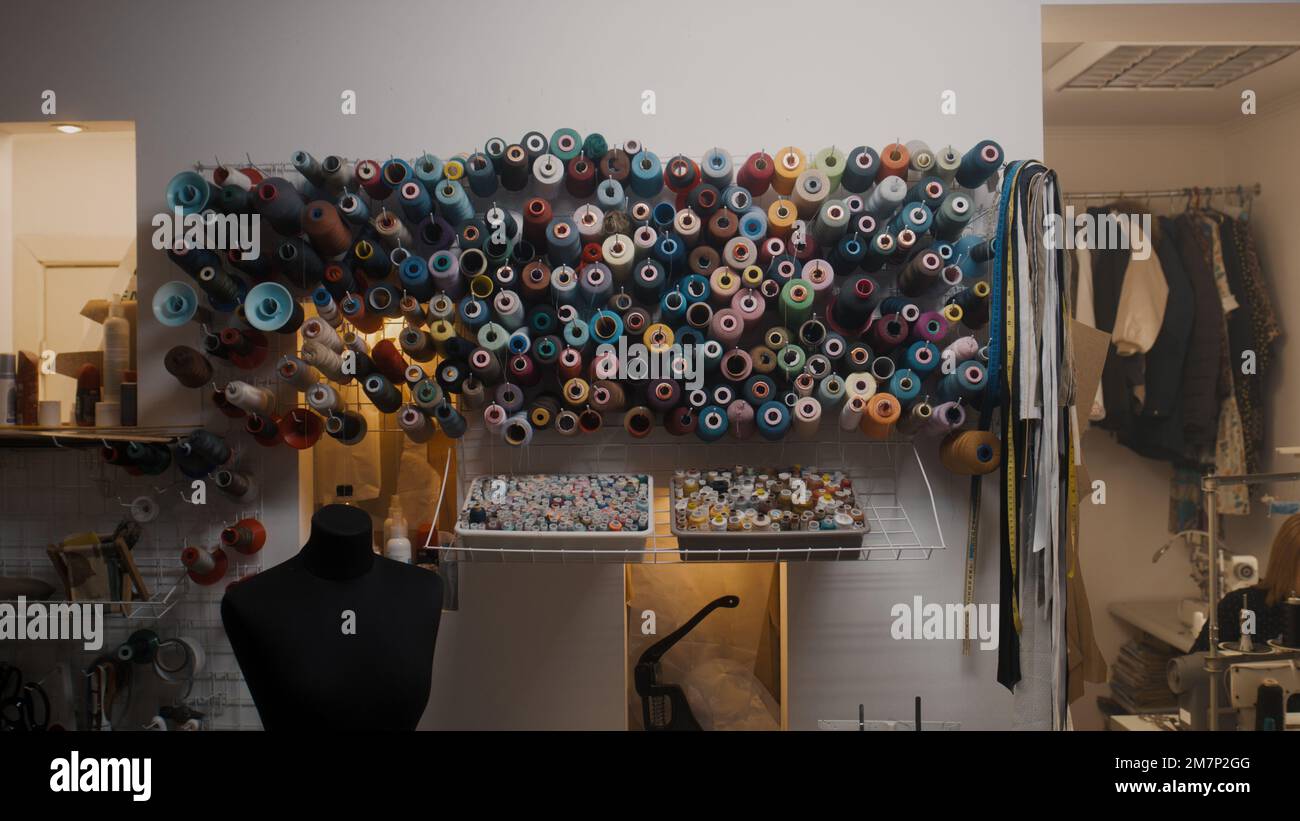 Fashion designer chooses color of threads for tailoring new wedding ...