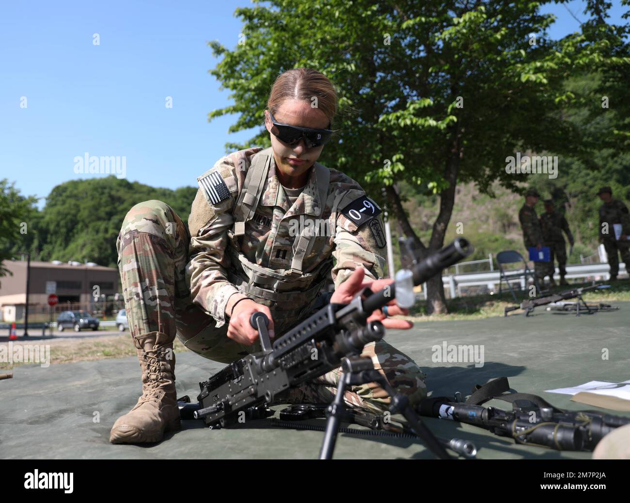 U.S. Army Capt. Caitlin Brennan disassembles an M-249 squad automatic ...