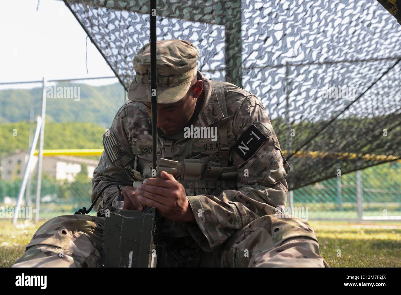 U.S. Army Sgt. 1st Class George Linen configures a Single Channel ...