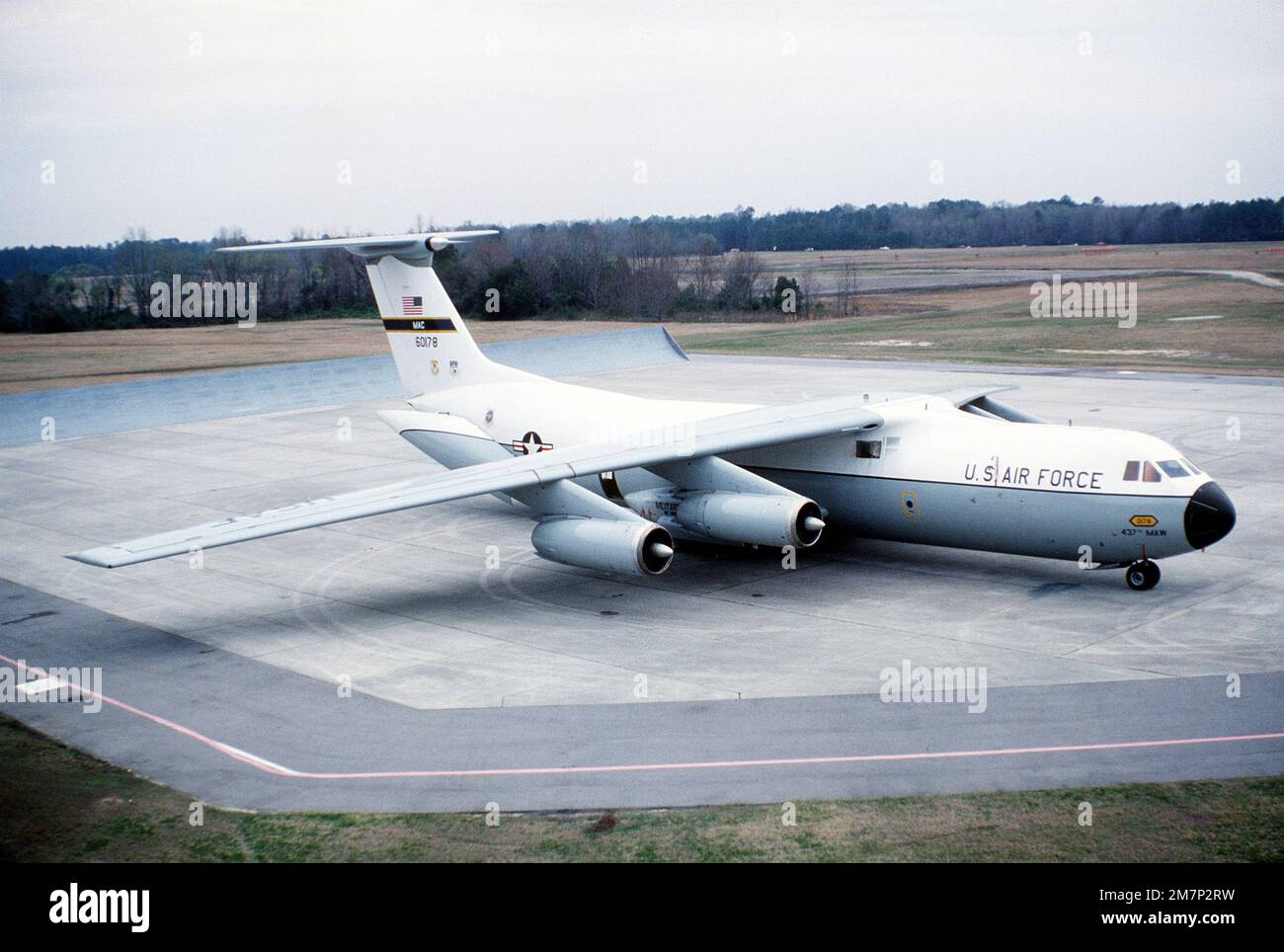 A front view of a C-141 Starlifter aircraft on ground. The aircraft is ...