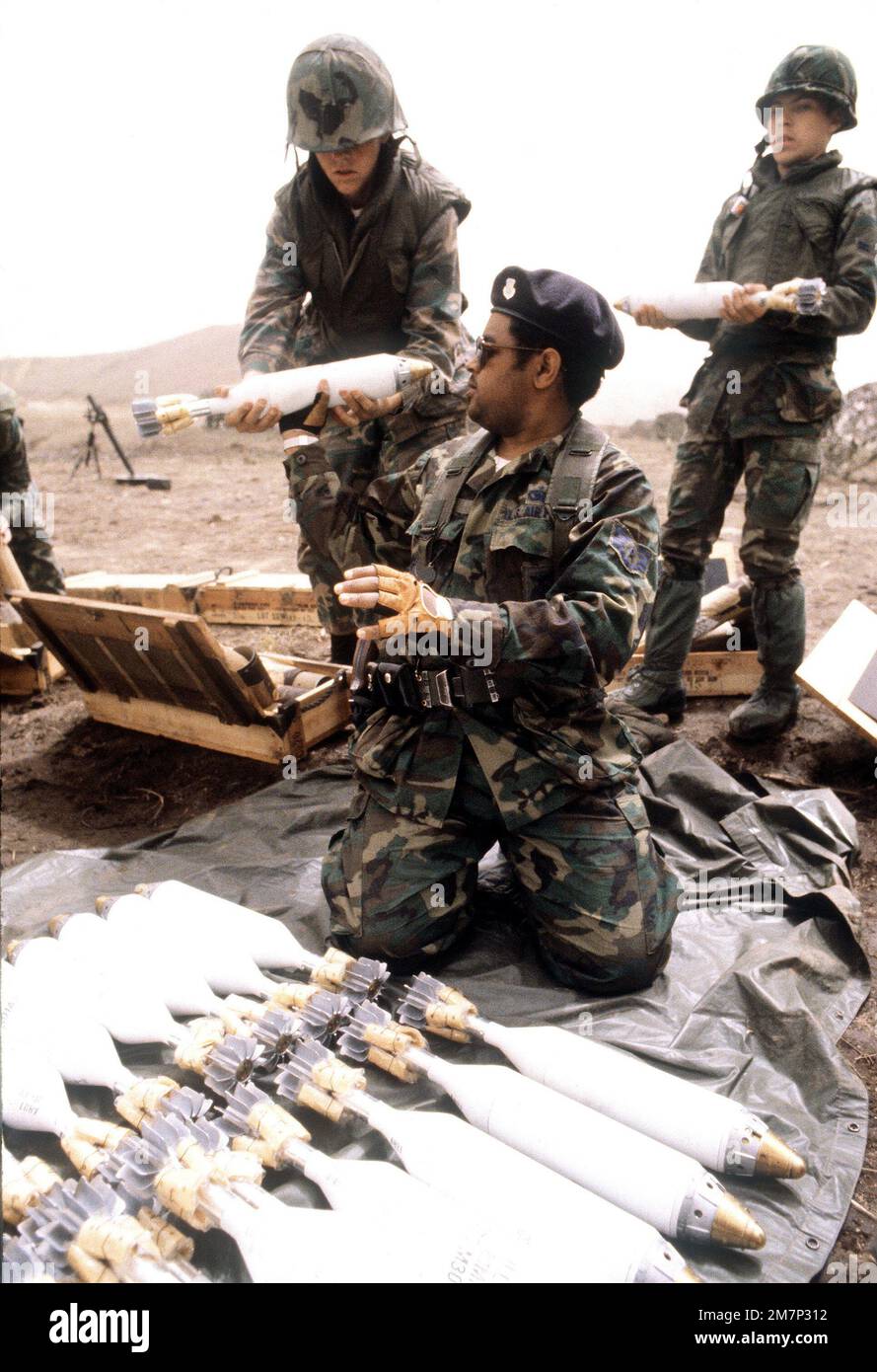 Security policeman set charges on and stack illumination mortar rounds ...