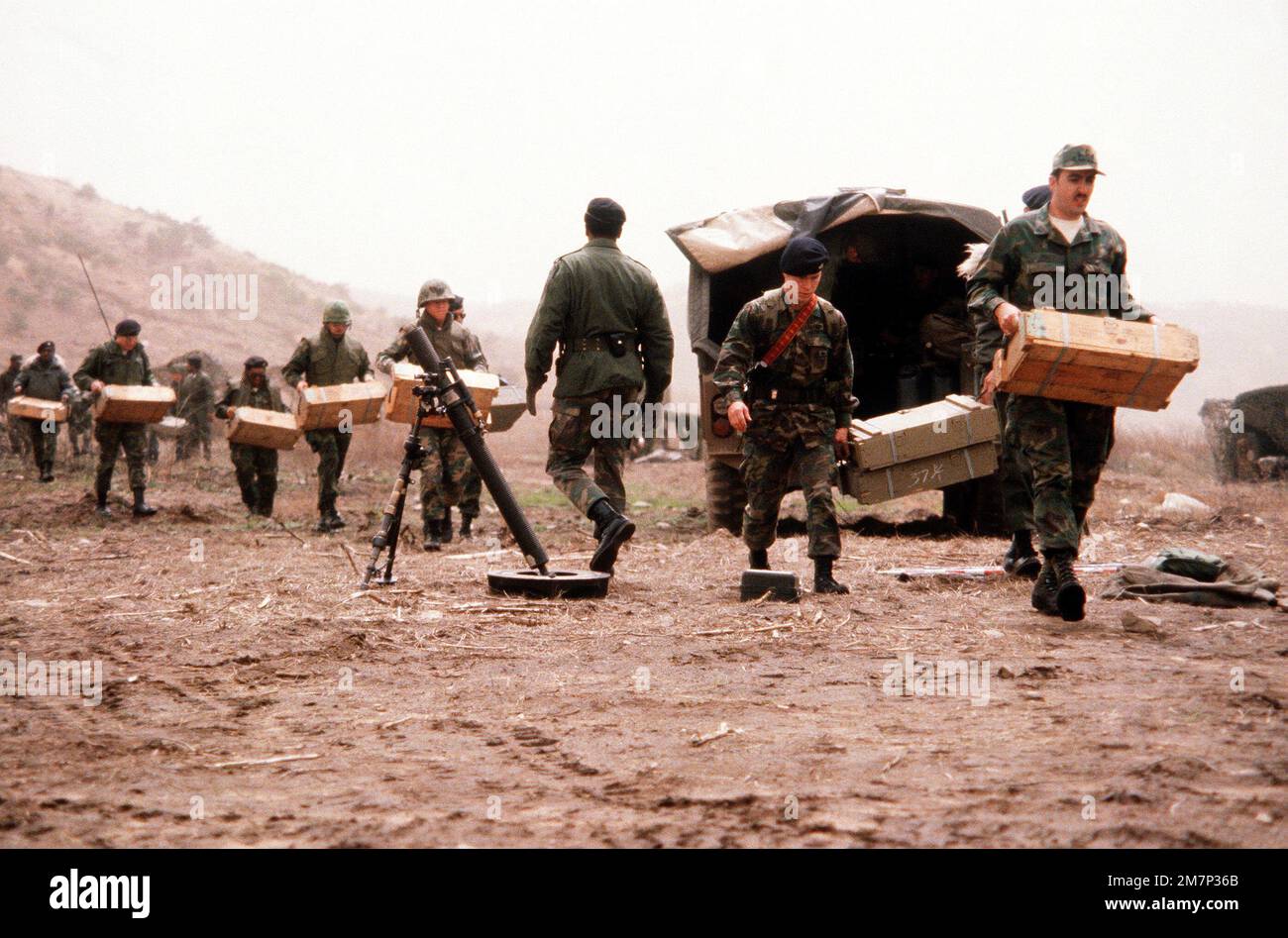 Security policemen unload boxes of mortar ammunition from trucks during ...