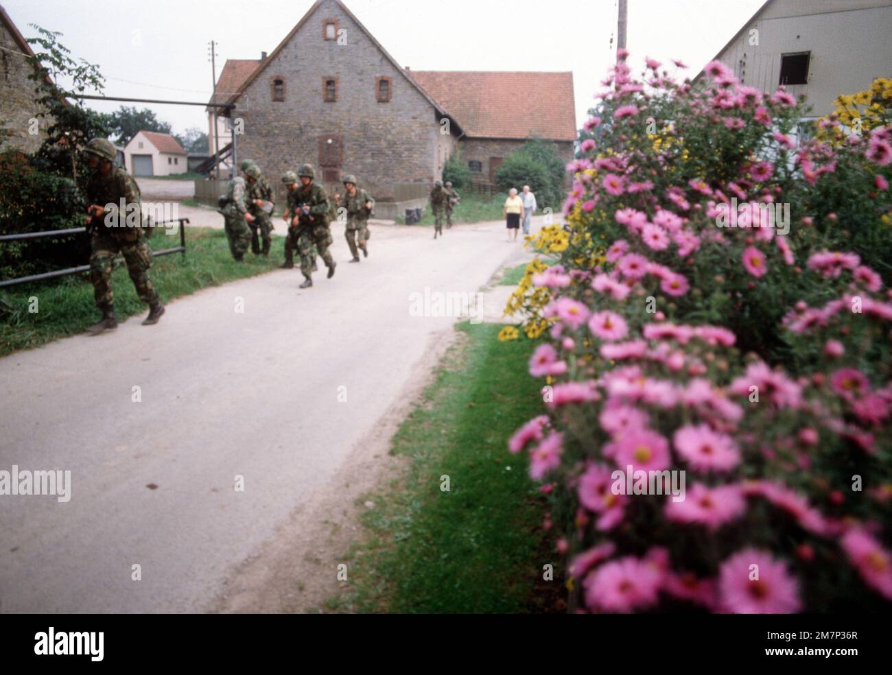 Troops of the 82nd Airborne Division patrol through a German village ...