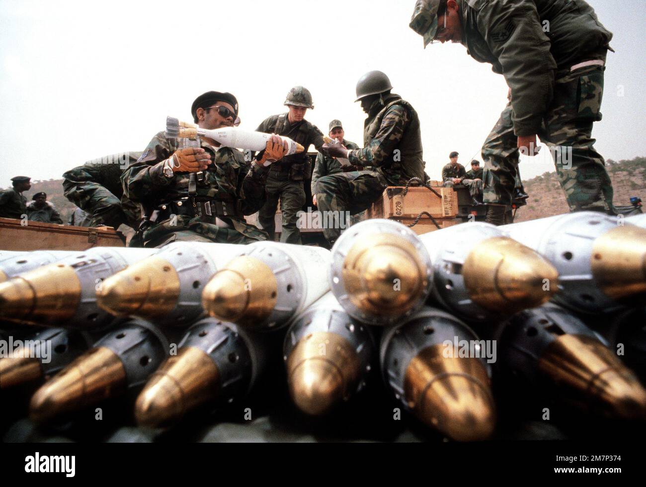 Security policemen set charges on and stack illumination mortar rounds ...