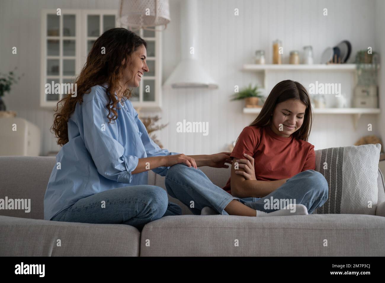 Positive caring woman wants to cheer up introverted teenage girl sits ...