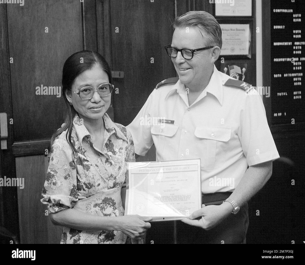 Euphrasia Pamintuan receives a suggestion award from her commander, COL ...