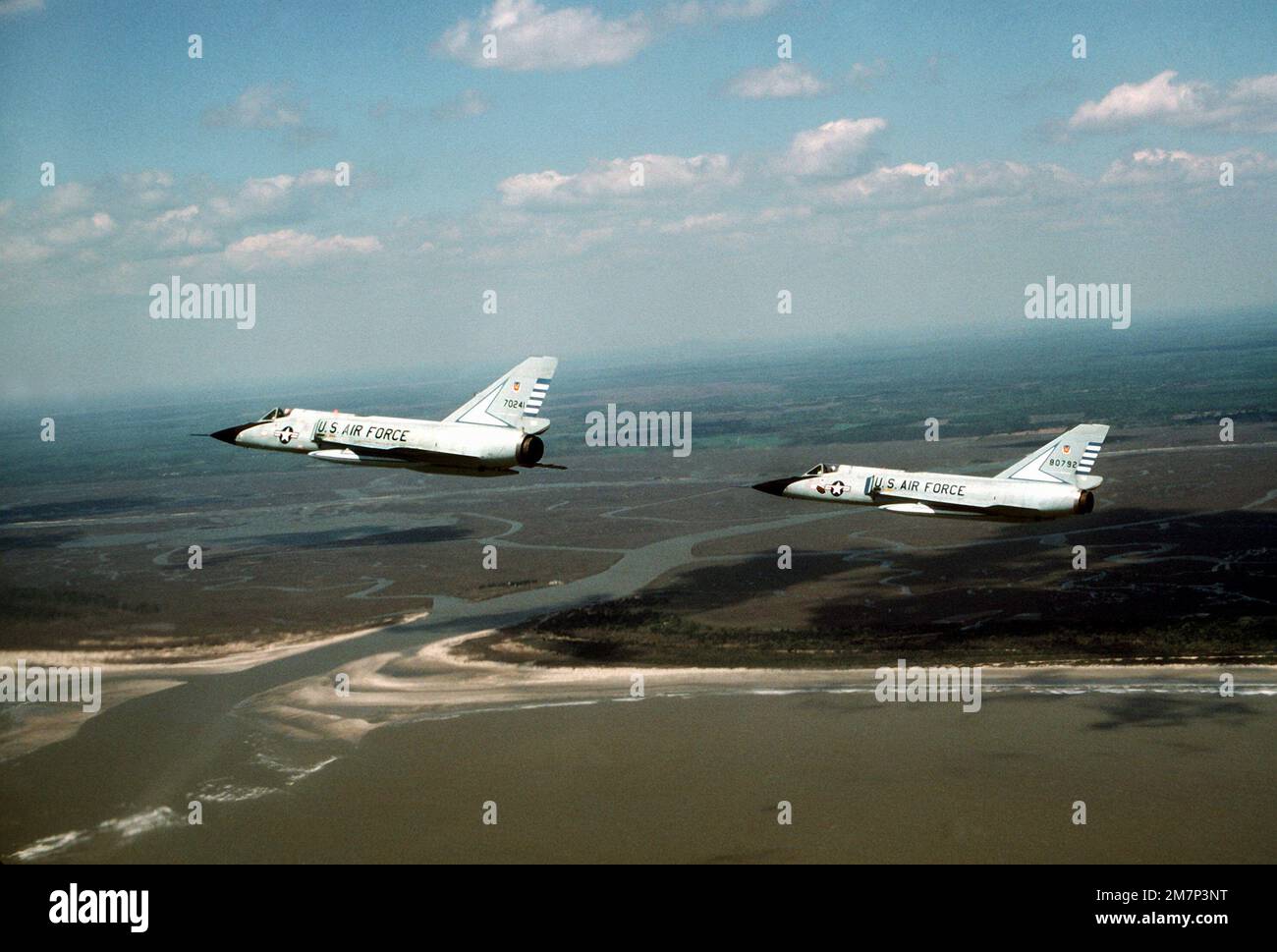 AN air-to-air left side view of two F-106 Delta Dart aircraft over the ...