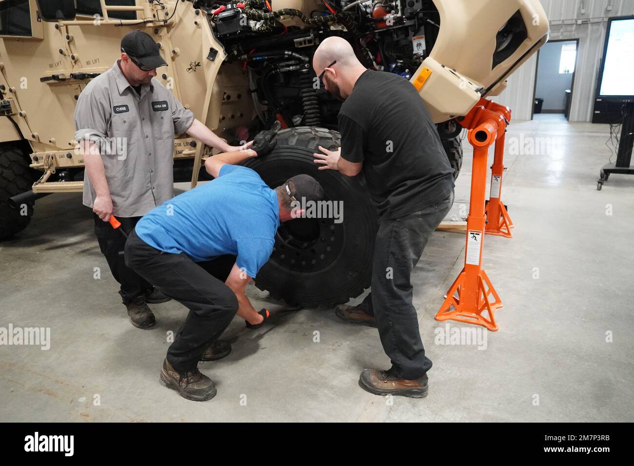 Students in the JLTV Phase II course install a tire. (Army photo by ...