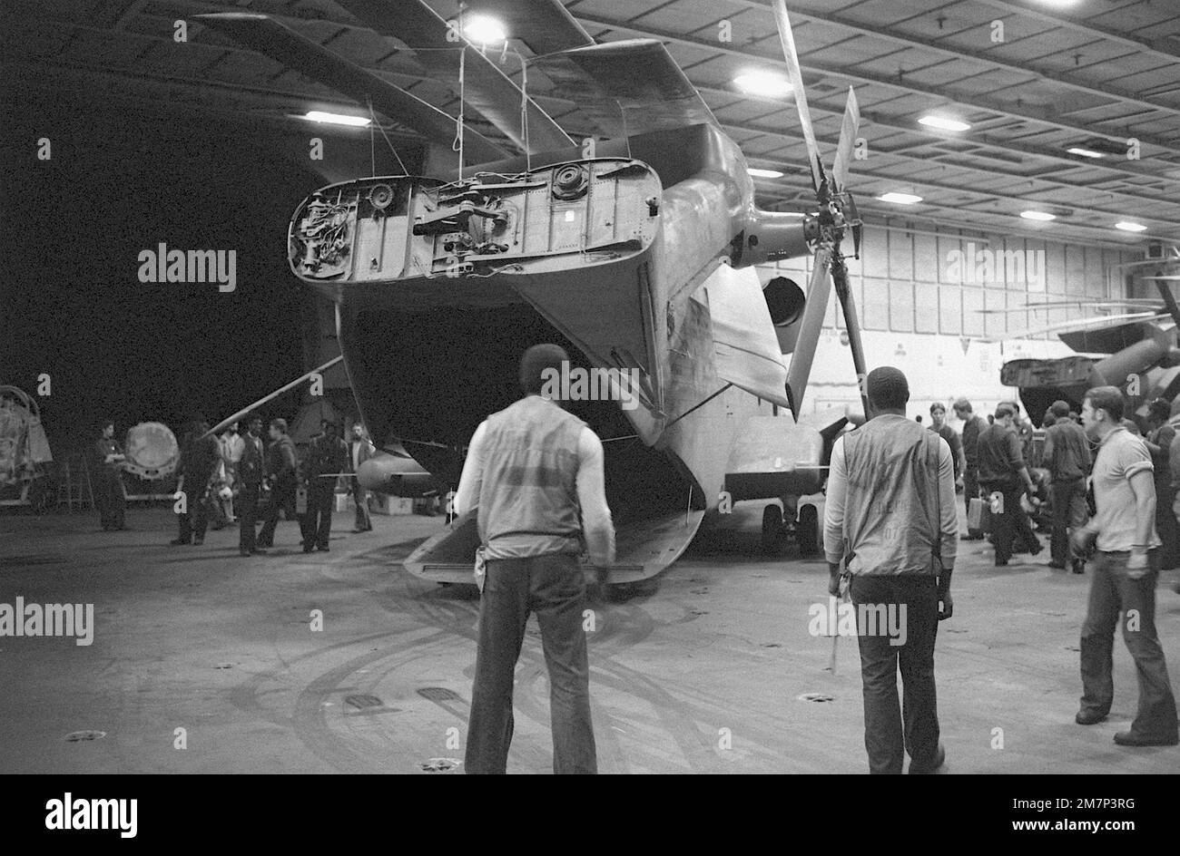 Crewmen in the hangar bay of the nuclear-powered aircraft carrier USS ...