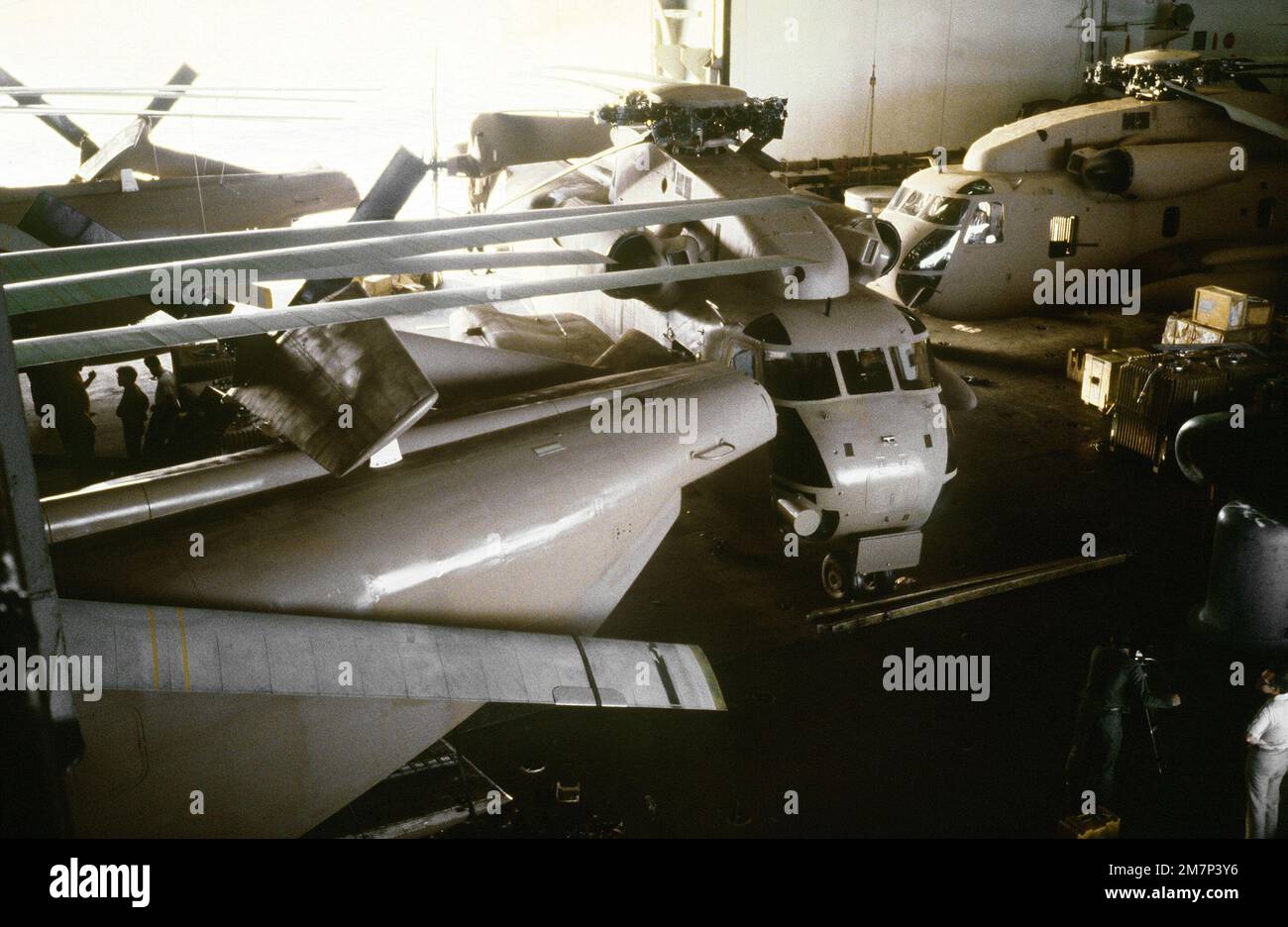 A view of four parked RH-53 Sea Stallion helicopters in the hangar bay ...