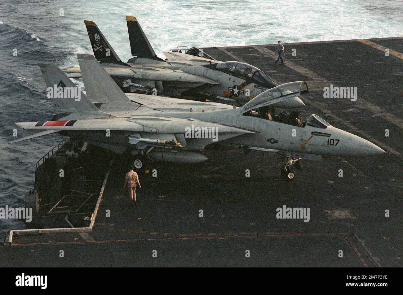 A right side view of two F-14 Tomcat fighter aircraft parked on the ...
