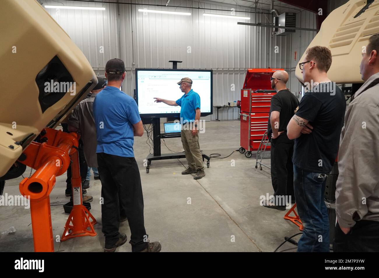 Gary Leamons (at white board), course instructor, points out a key ...