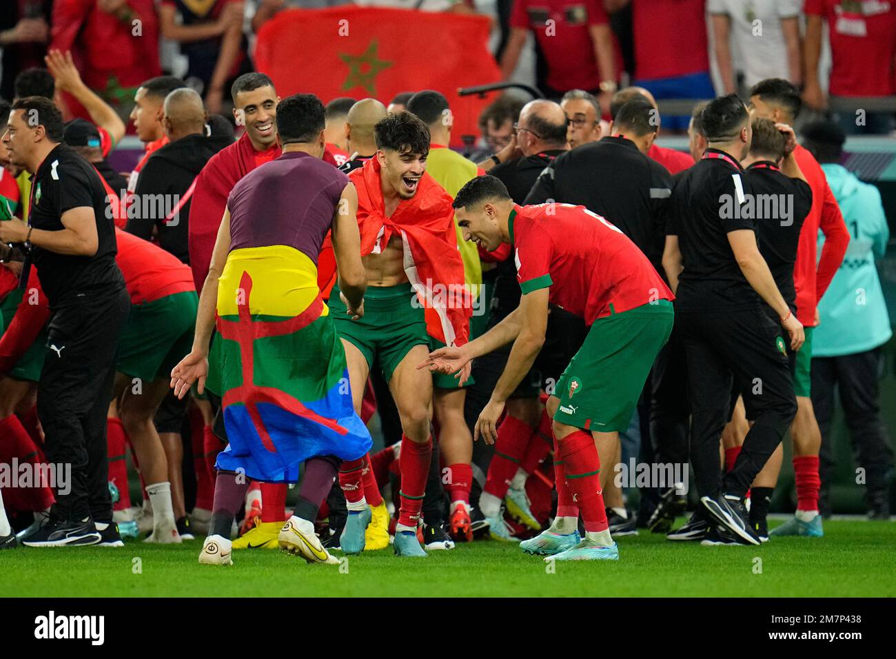 Morocco's players celebrate at the end of the World Cup round of 16 ...