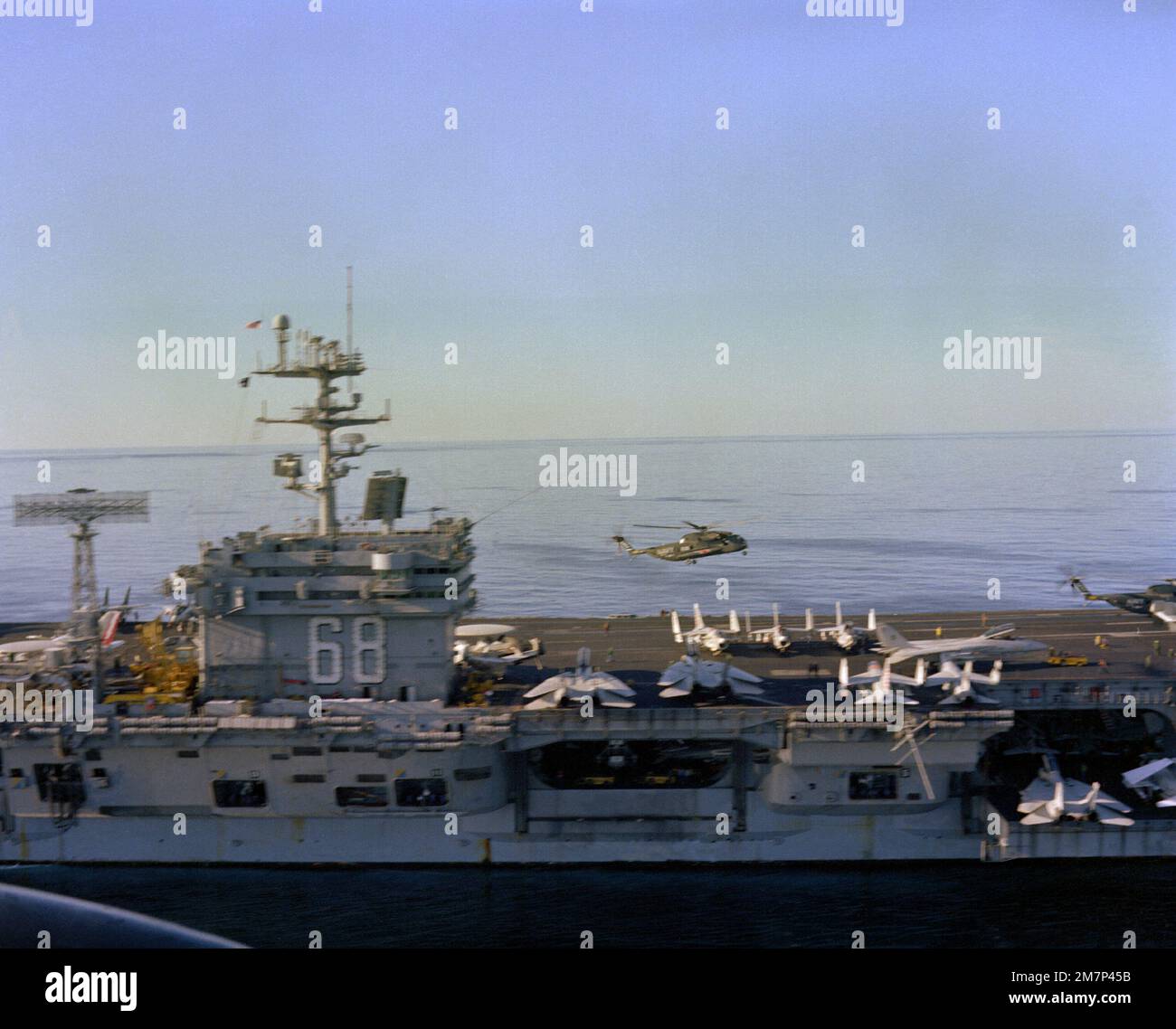 A starboard beam view of the island and forward deck of the nuclear-powered aircraft carrier USS ...