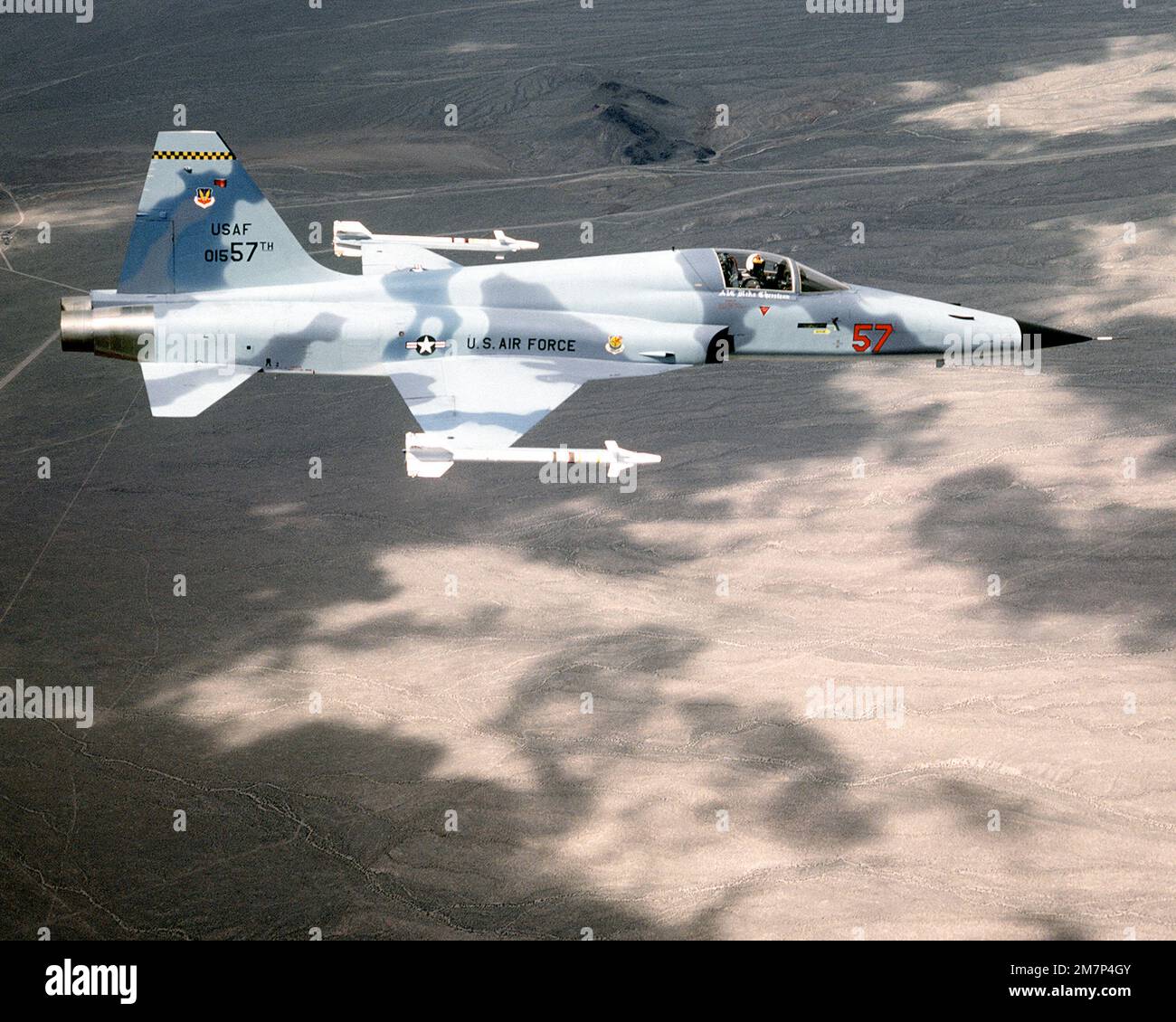 AN air-to-air right side view of an F-5 Tiger II aircraft over a range ...