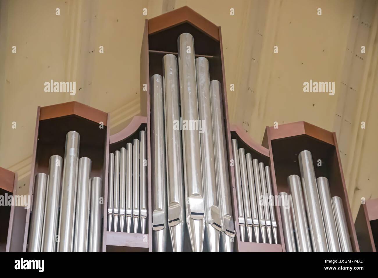 Church pipe organ instrument made of metal and wood, in Catholic church ...