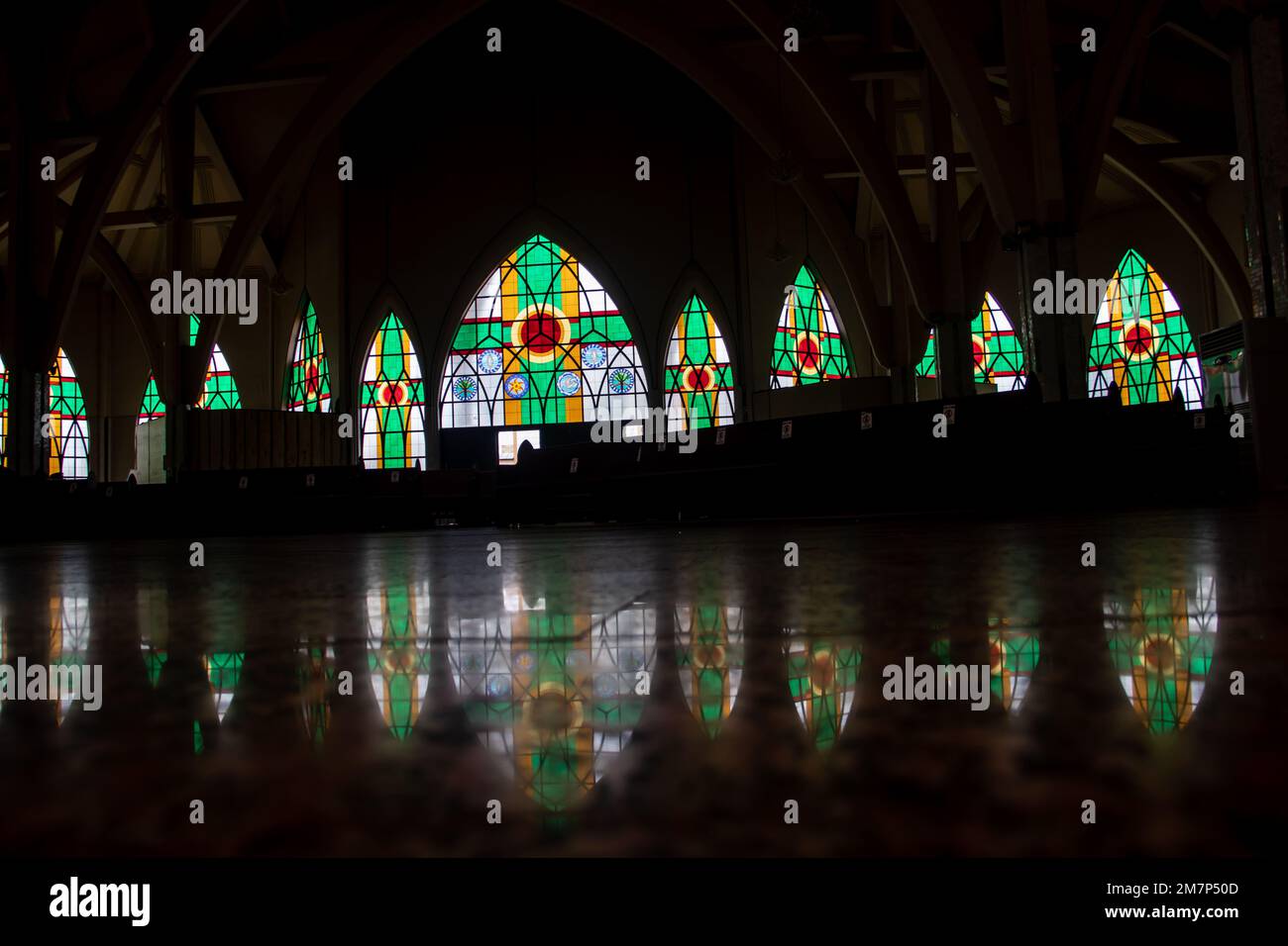Enterior with arches, crosses and stained glass window inside Catholics ...