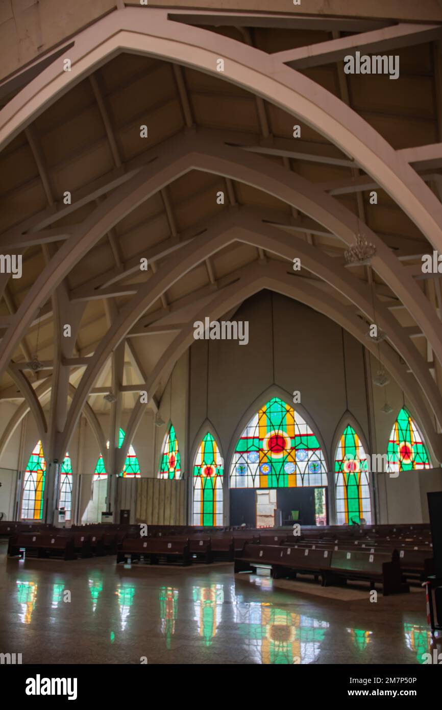 Enterior with arches, crosses and stained glass window inside Catholics ...