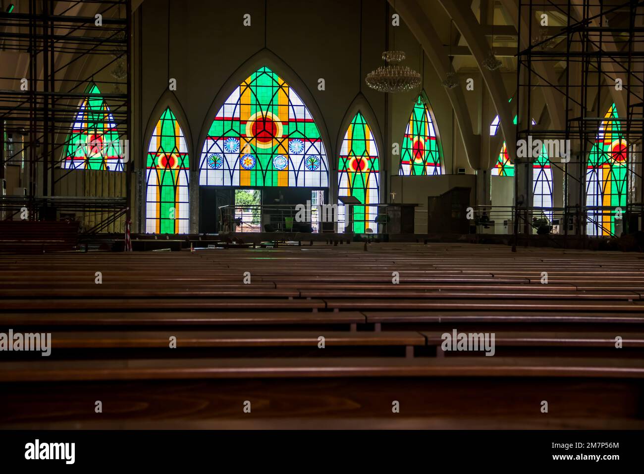 Enterior with arches, crosses and stained glass window inside Catholics ...