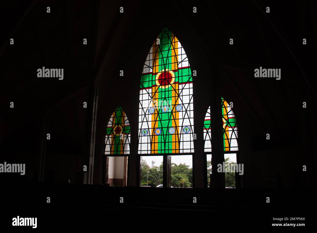 Enterior with arches, crosses and stained glass window inside Catholics ...