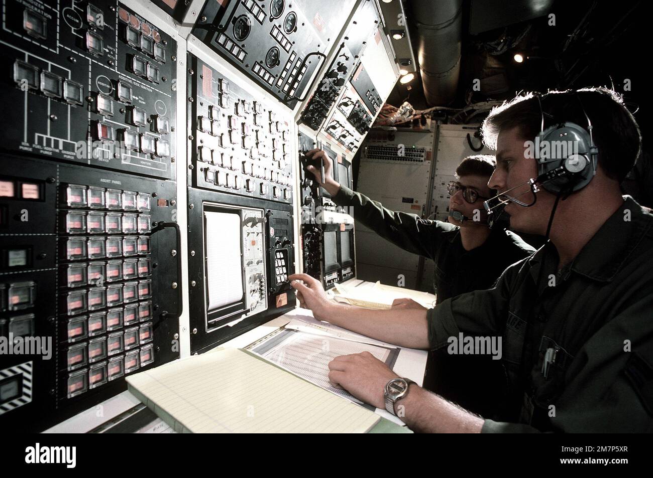 Test crew members work at their stations aboard an NKC-135 airborne ...