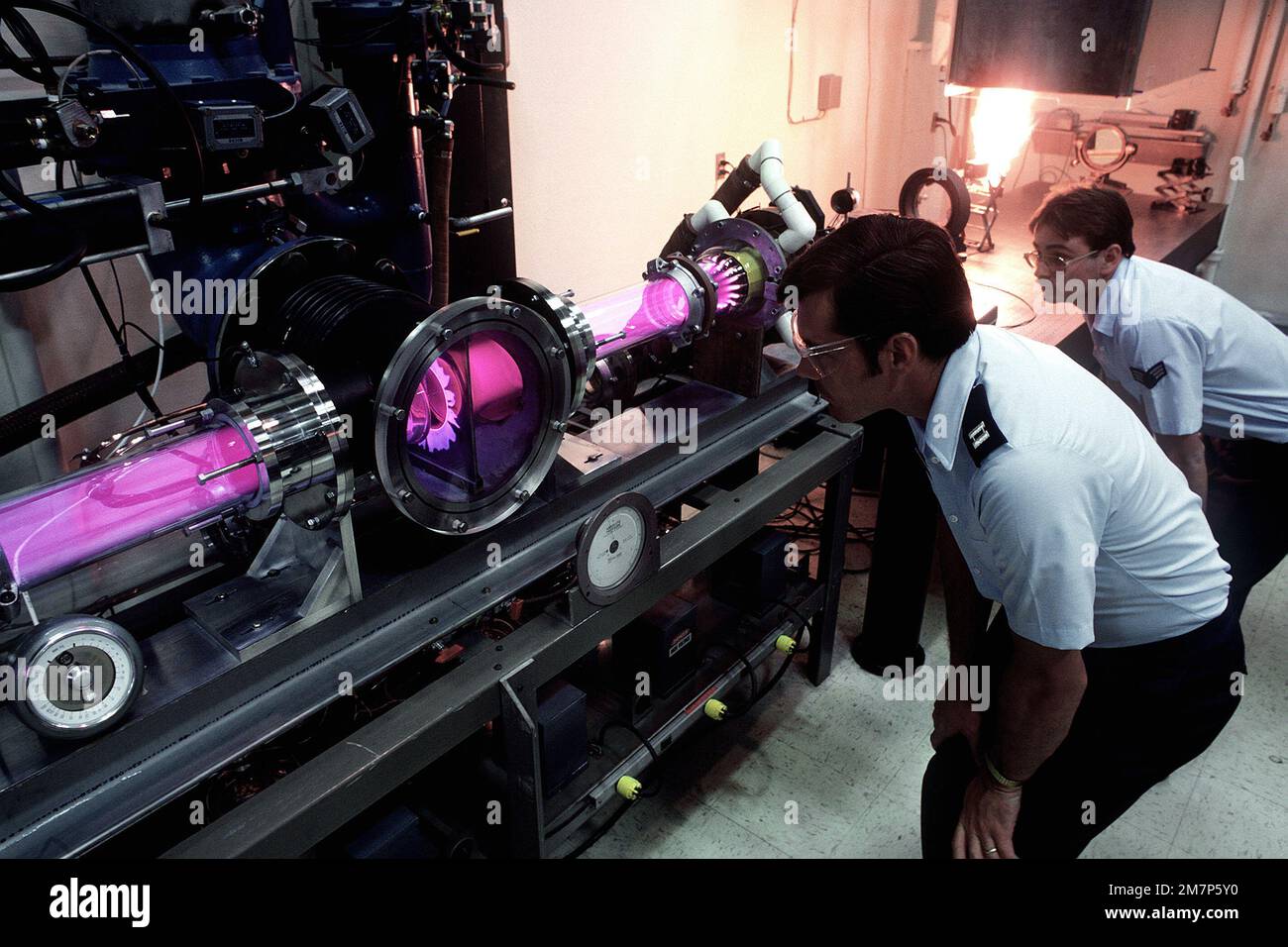 Two laser engineering technicians conduct an experiment with an ...