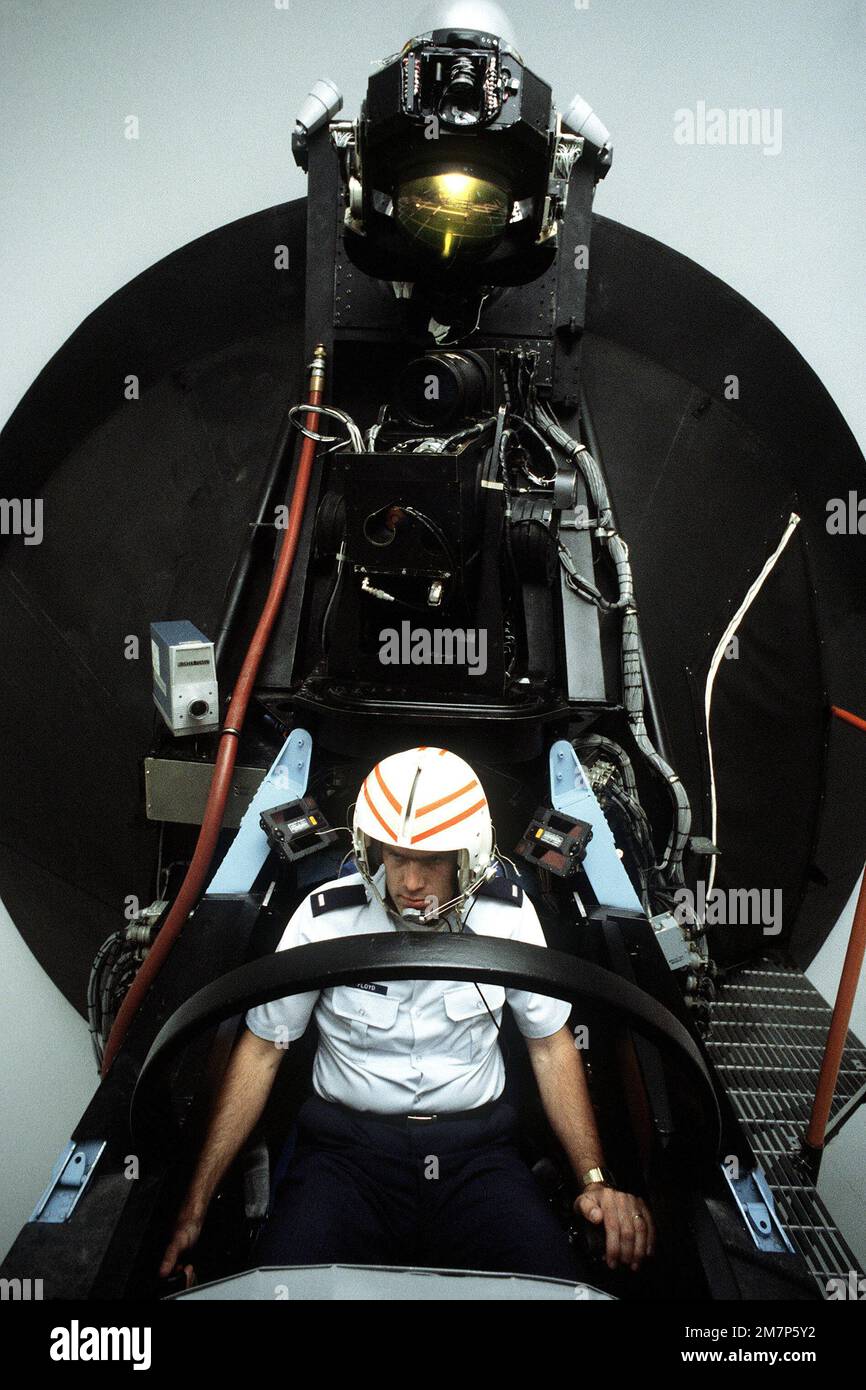 A pilot trains in an F-16 Fighting Falcon aircraft simulator. Base ...