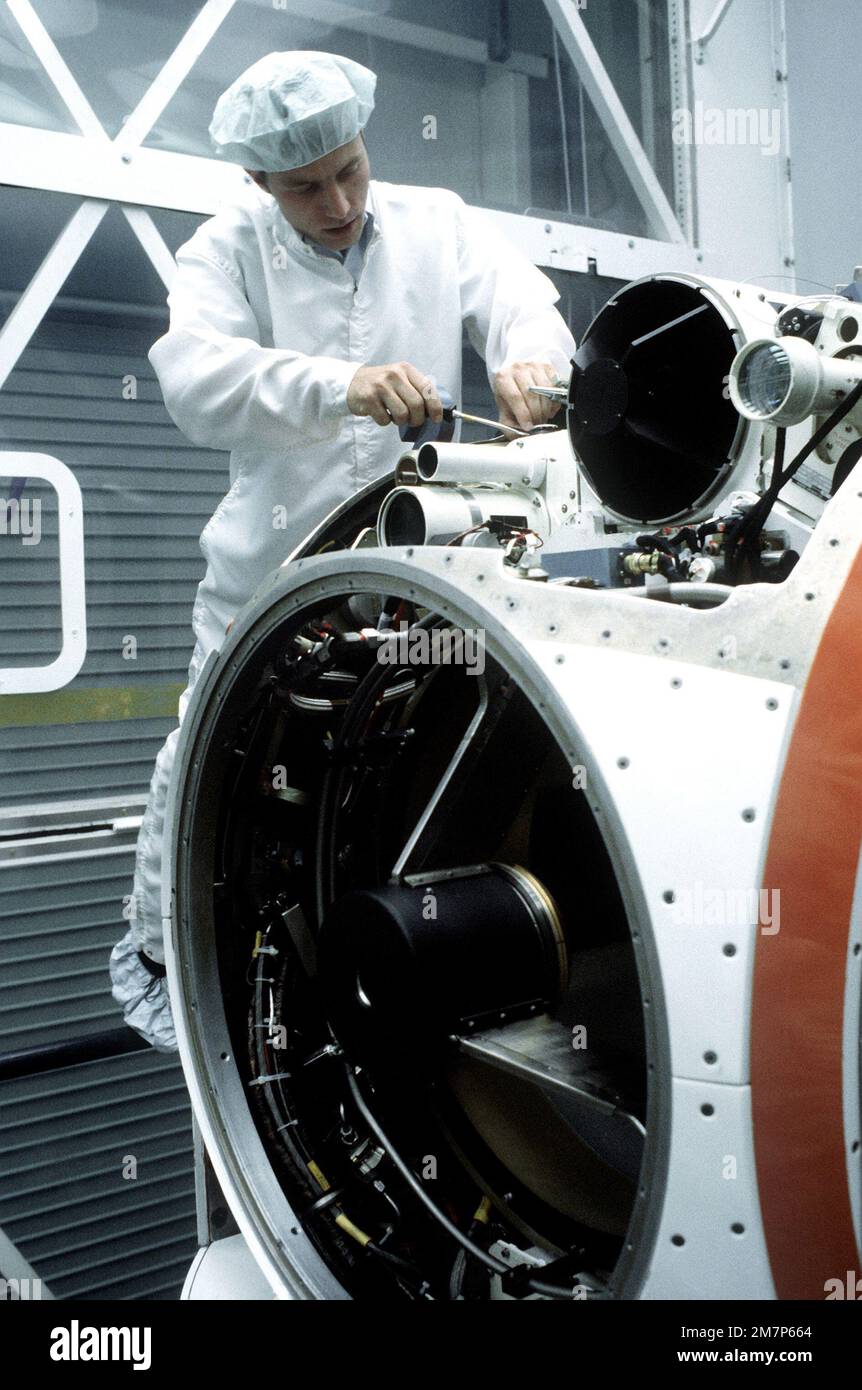 A technician adjusts the pointer and tracker current/telescope to be ...