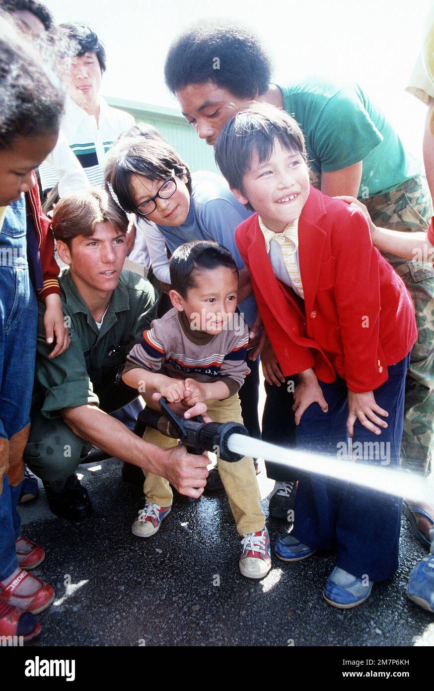 AMN Johnny Powers lets visiting Amerasian children (the children of ...