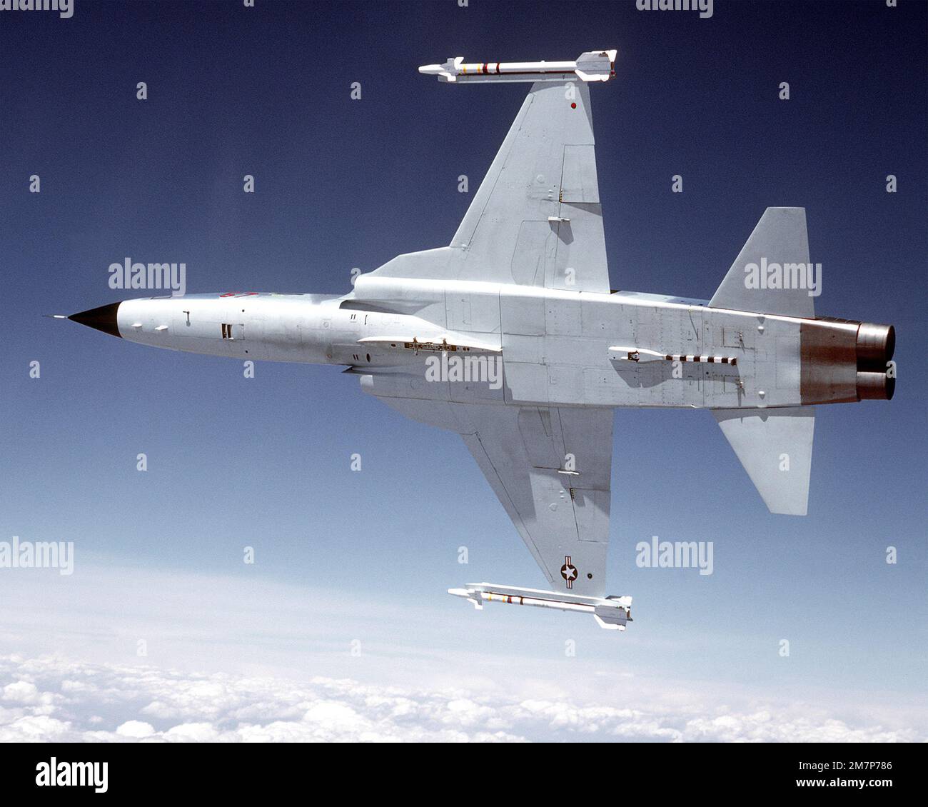 View of the bottom of an F-5 Tiger II aircraft as the jet banks to the ...