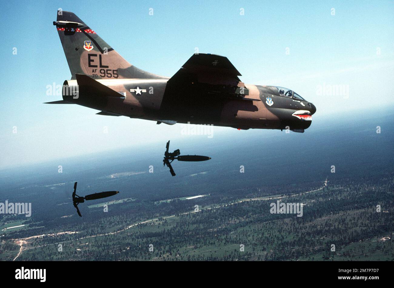 AN air-to-air right side view of an A-7D Corsair II aircraft releasing ...