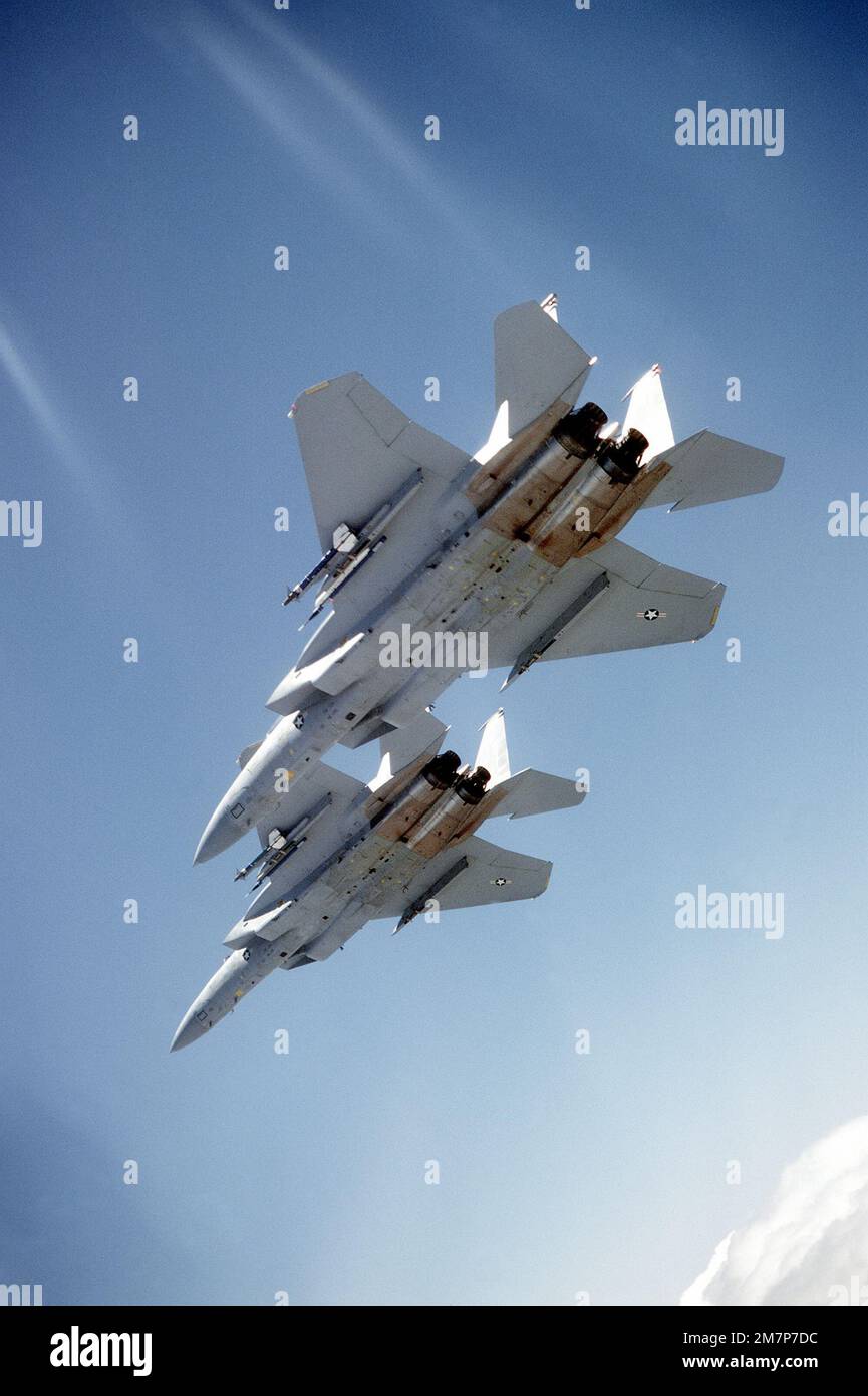 AN air-to-air left underside view of two F-15 Eagle aircraft returning ...