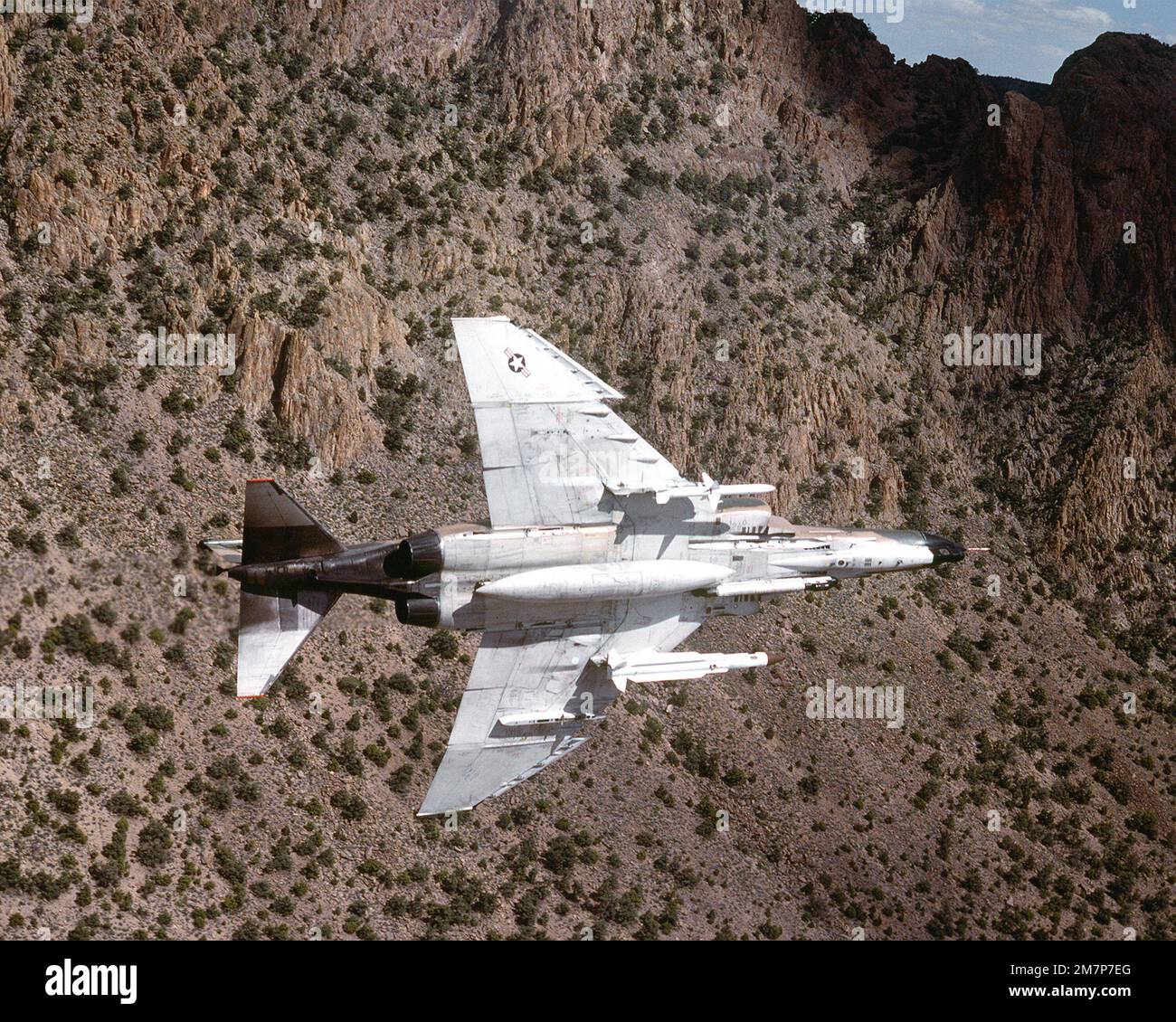 AN air-to-air underside view of an F-4G Phantom II Wild Weasel aircraft ...