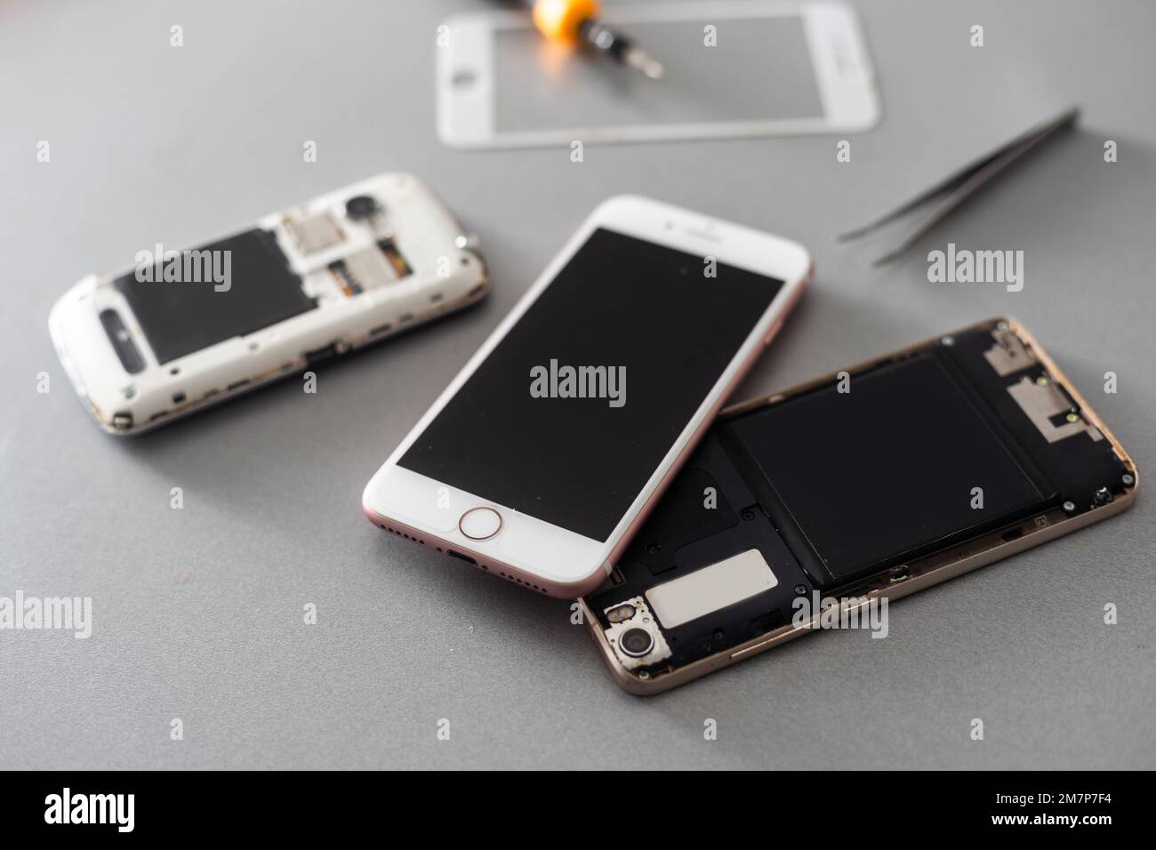 The technician repairing the smartphone's motherboard in the lab with ...