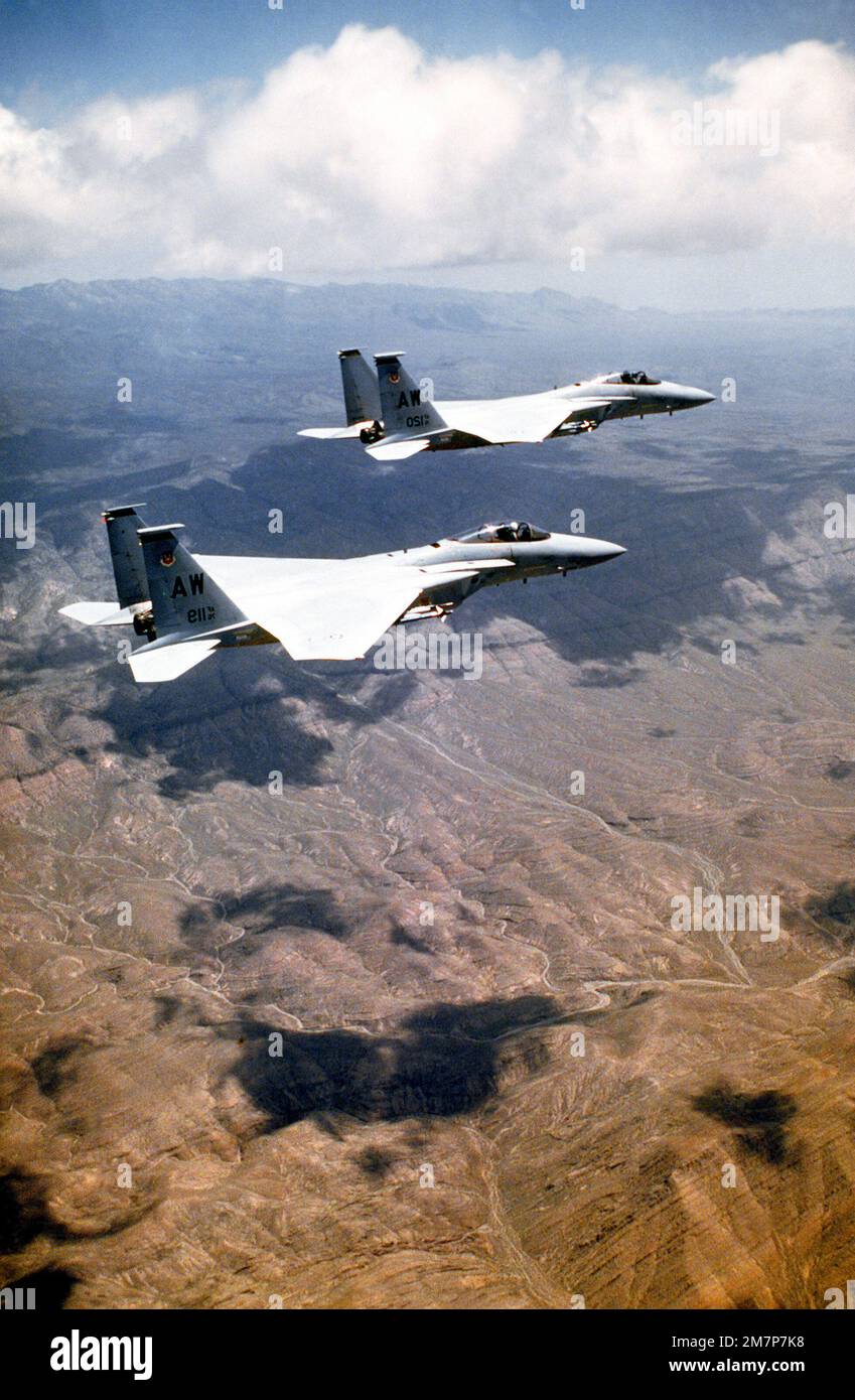 AN air-to-air left side view of two F-15 Eagle aircraft returning from ...