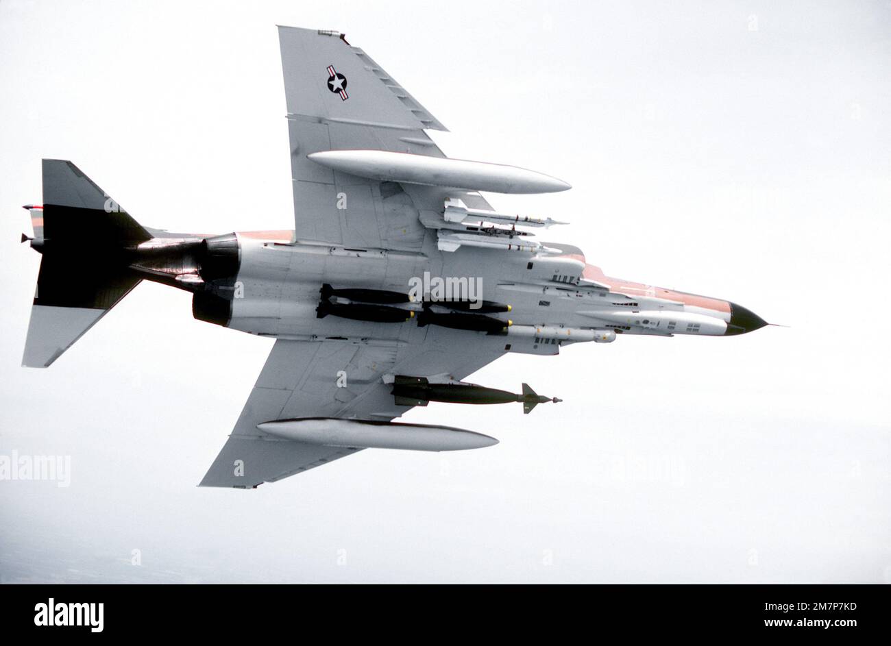 AN air-to-air underside view of an F-4E Phantom II aircraft banking to ...