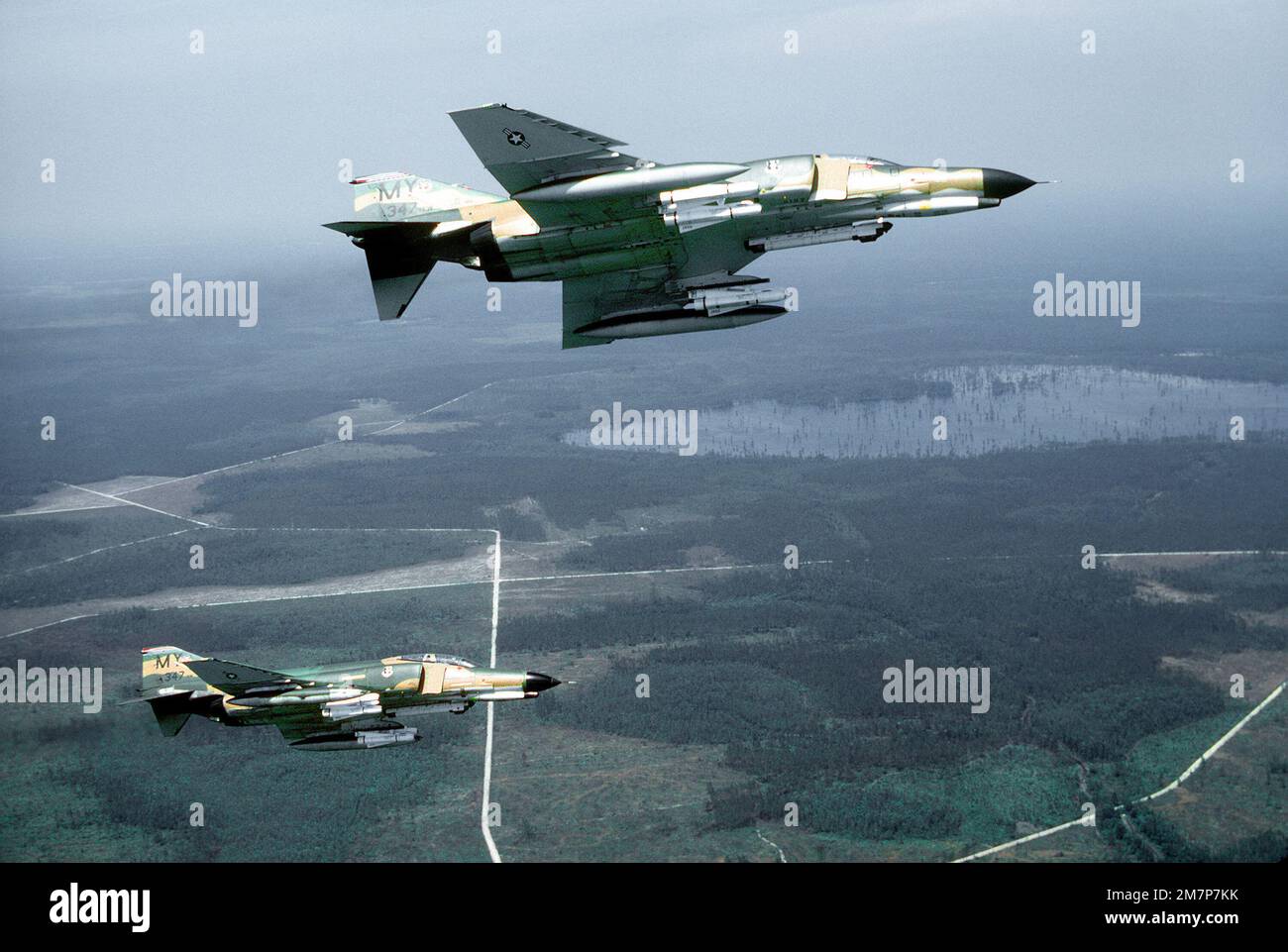 AN air-to-air right side view of two F-4E Phantom II aircraft banking ...