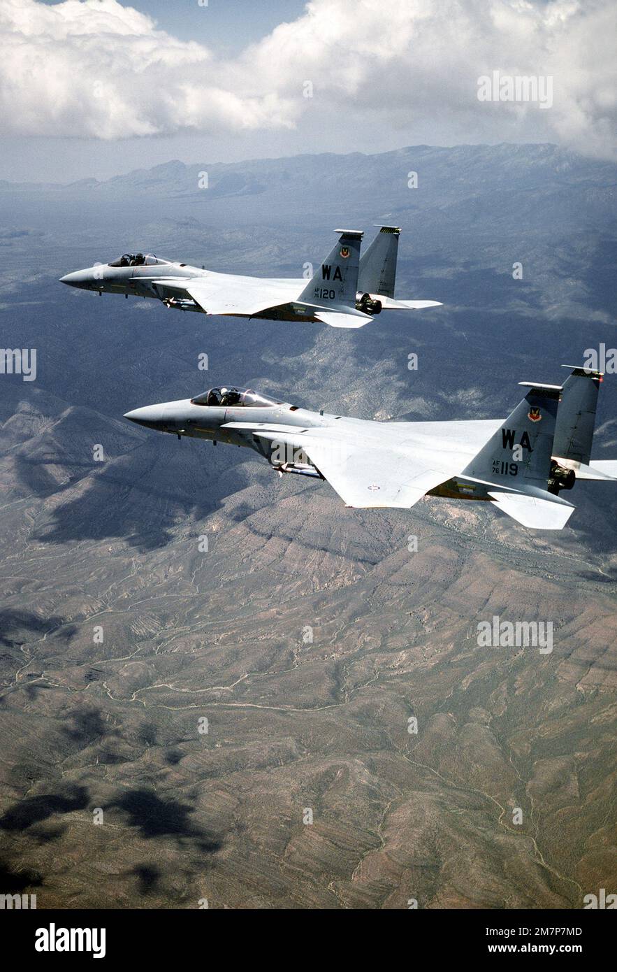 AN air-to-air left side view of two F-15 Eagle aircraft returning from ...