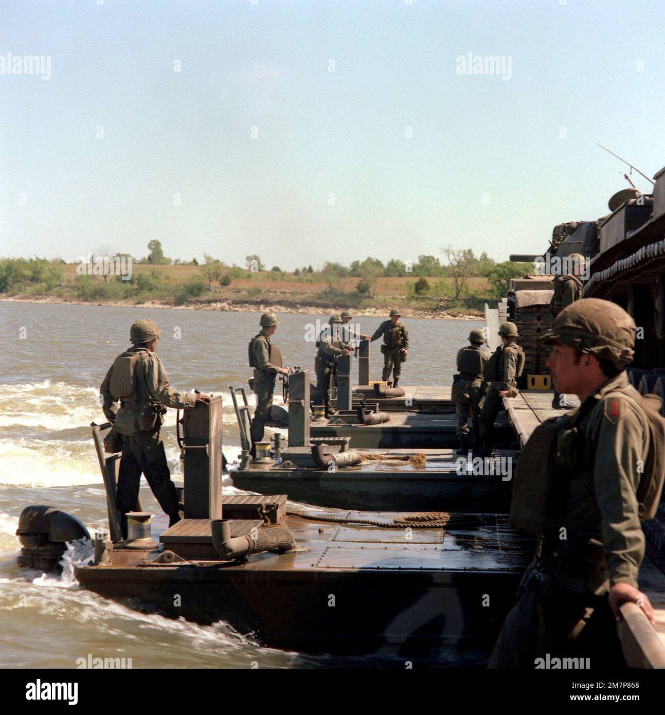 Members of Company E, 1ST Engineer Battalion transport tanks across a ...