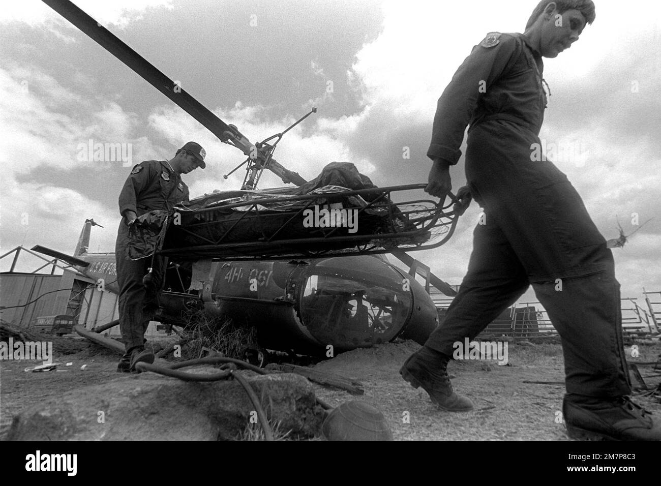 Pararescuemen use a litter to remove one of the "victims" from a ...