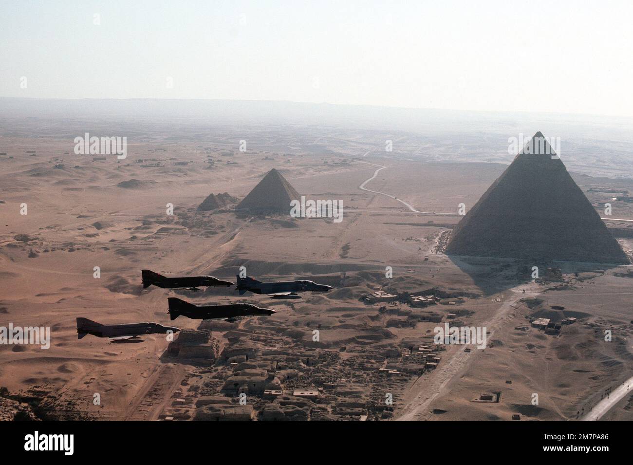 AN air-to-air right side view of four F-4E Phantom II aircraft flying ...