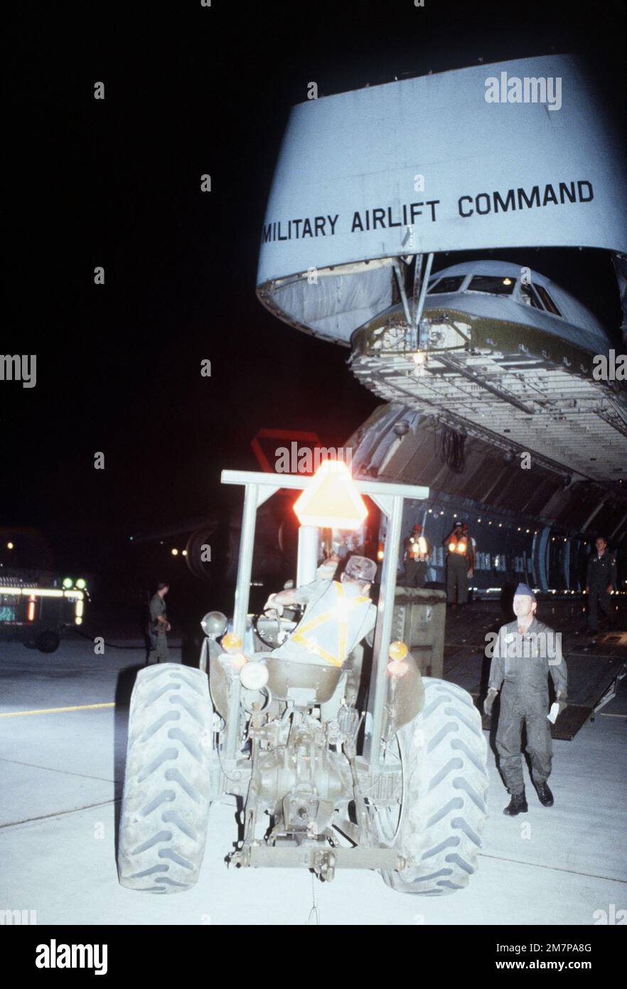 An airman uses a forklift to load cargo onto a C-5A Galaxy aircraft at ...