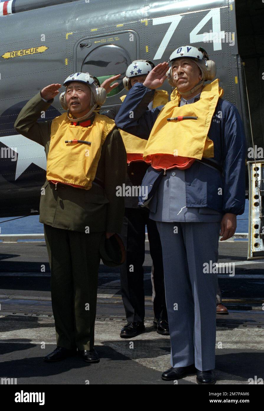 Vice Premier Gen Biao of China and a member of his delegation salute as ...