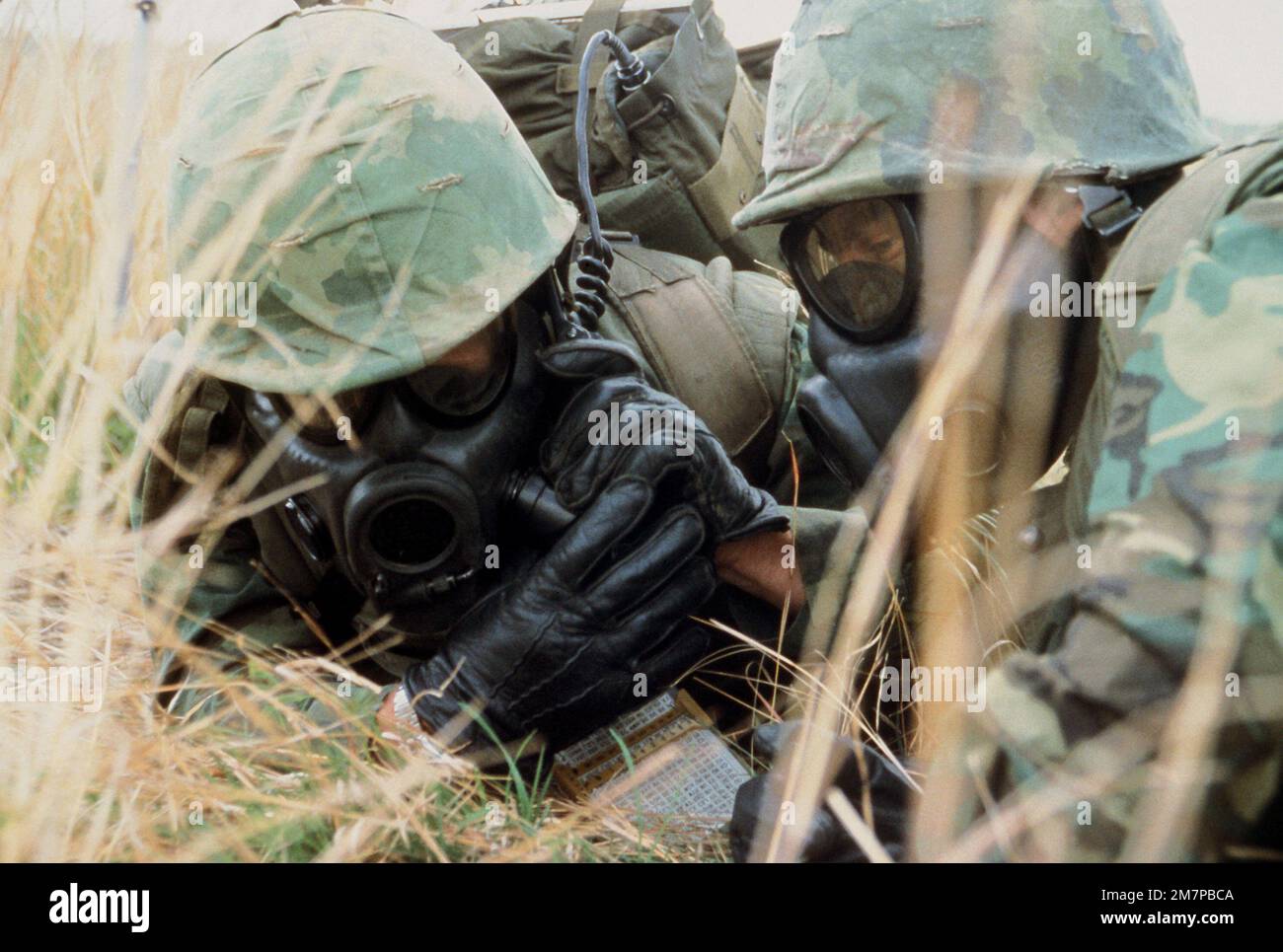 Marine officers, wearing chemical warfare gear, are trained in combat ...