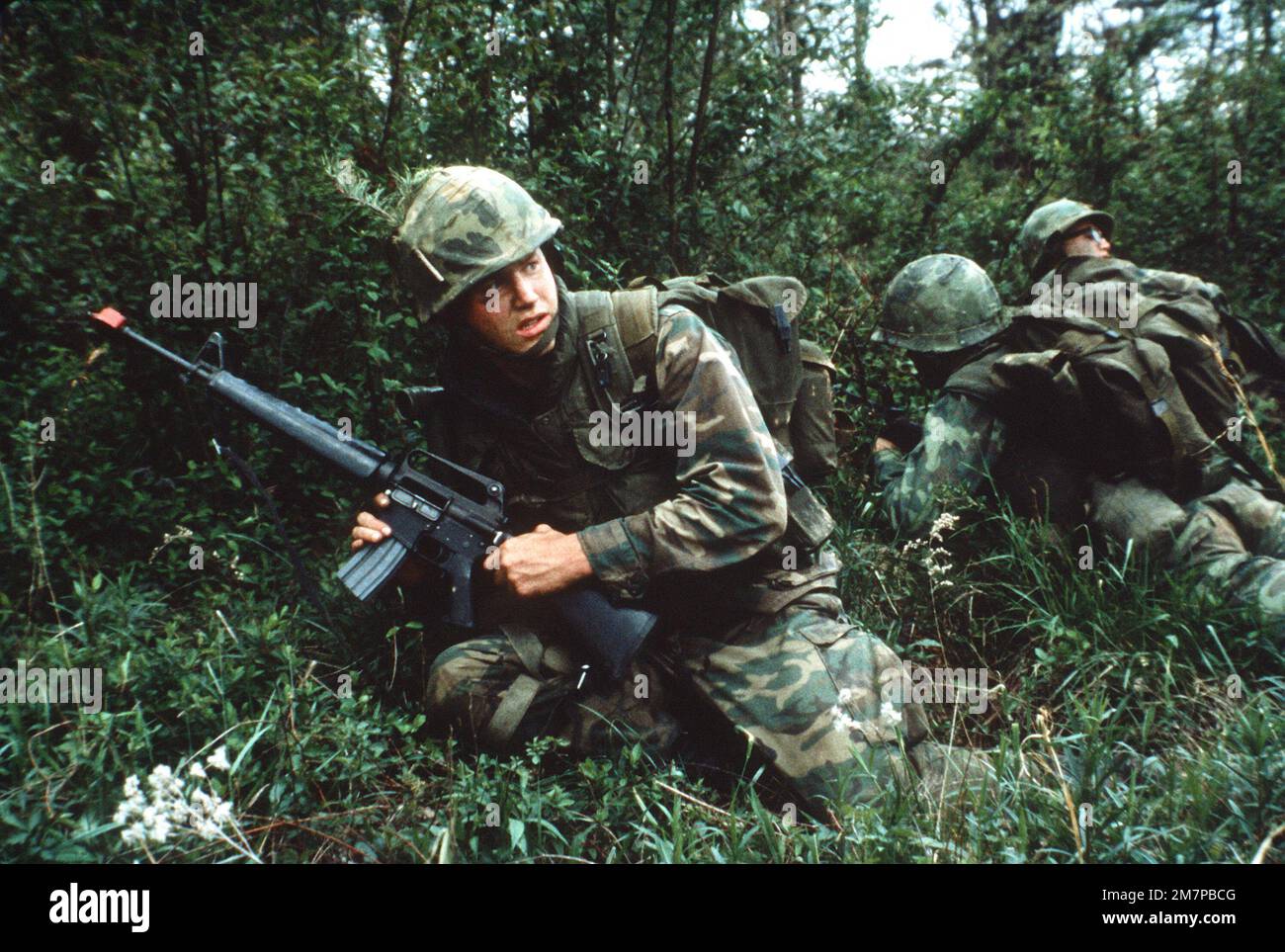 Marine officers armed with M-16A1 rifles prepare to defend their ...